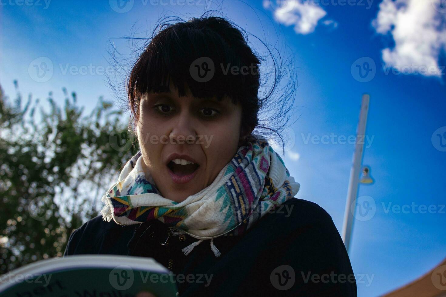 Surprised woman reading book 27613203 Stock Photo at Vecteezy