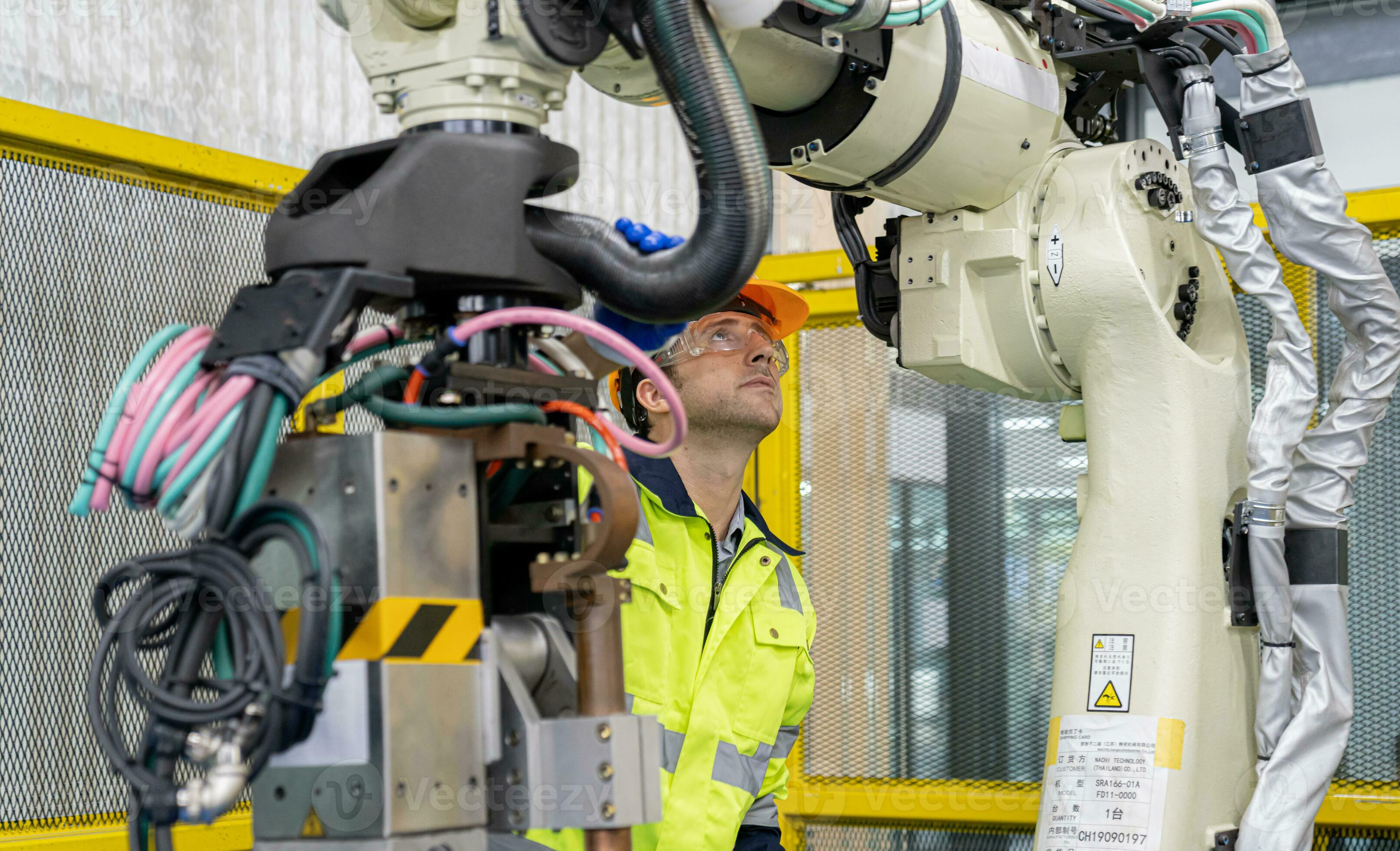 Engineer working and controlling robotics with monitoring system software automation robot arm ...