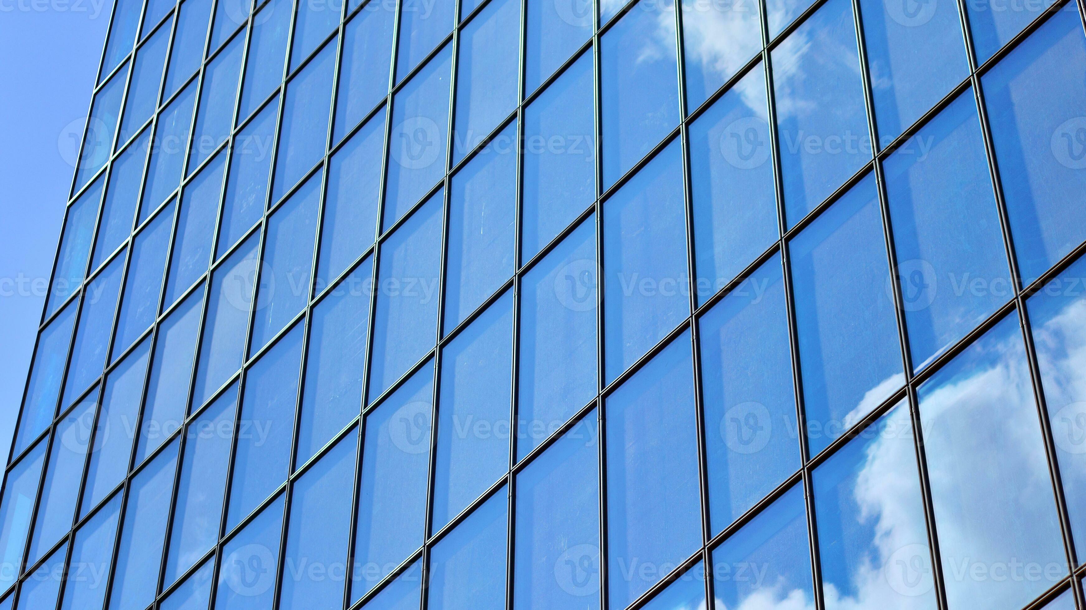 Structural glass wall reflecting blue sky. Abstract modern architecture ...