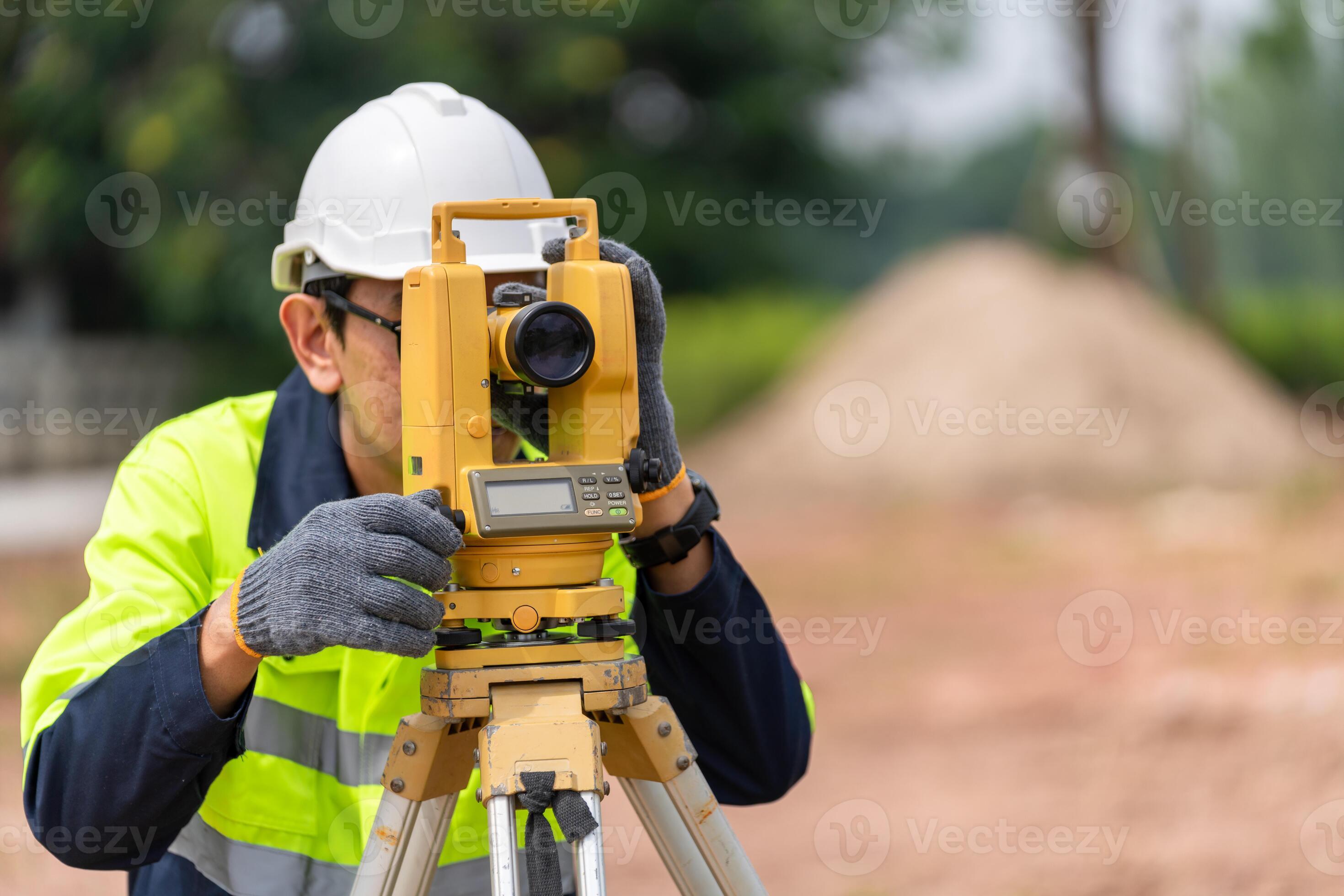 Surveyor Civil Engineer using equipment theodolite or total positioning station on the ...