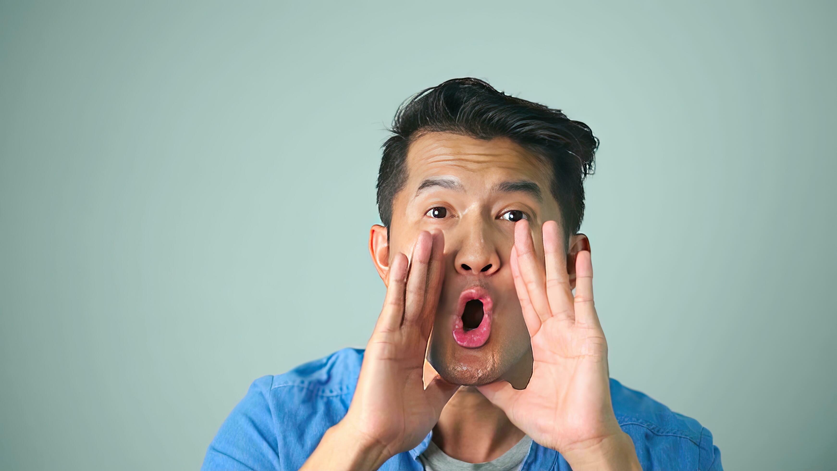 Asian man yelling and hand on his mouth, on White background copy space ...