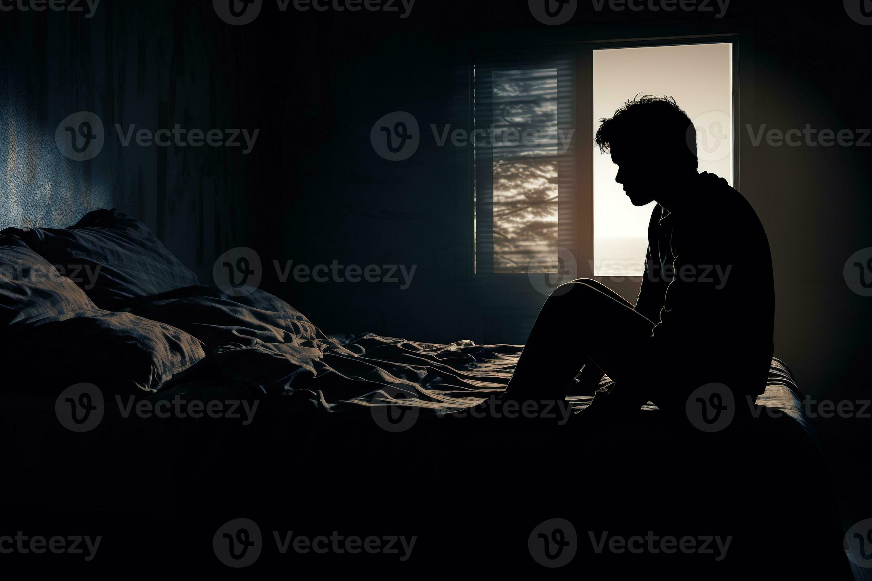 Silhouette depressed man sadly sitting on the bed in the bedroom. Sad asian man suffering ...