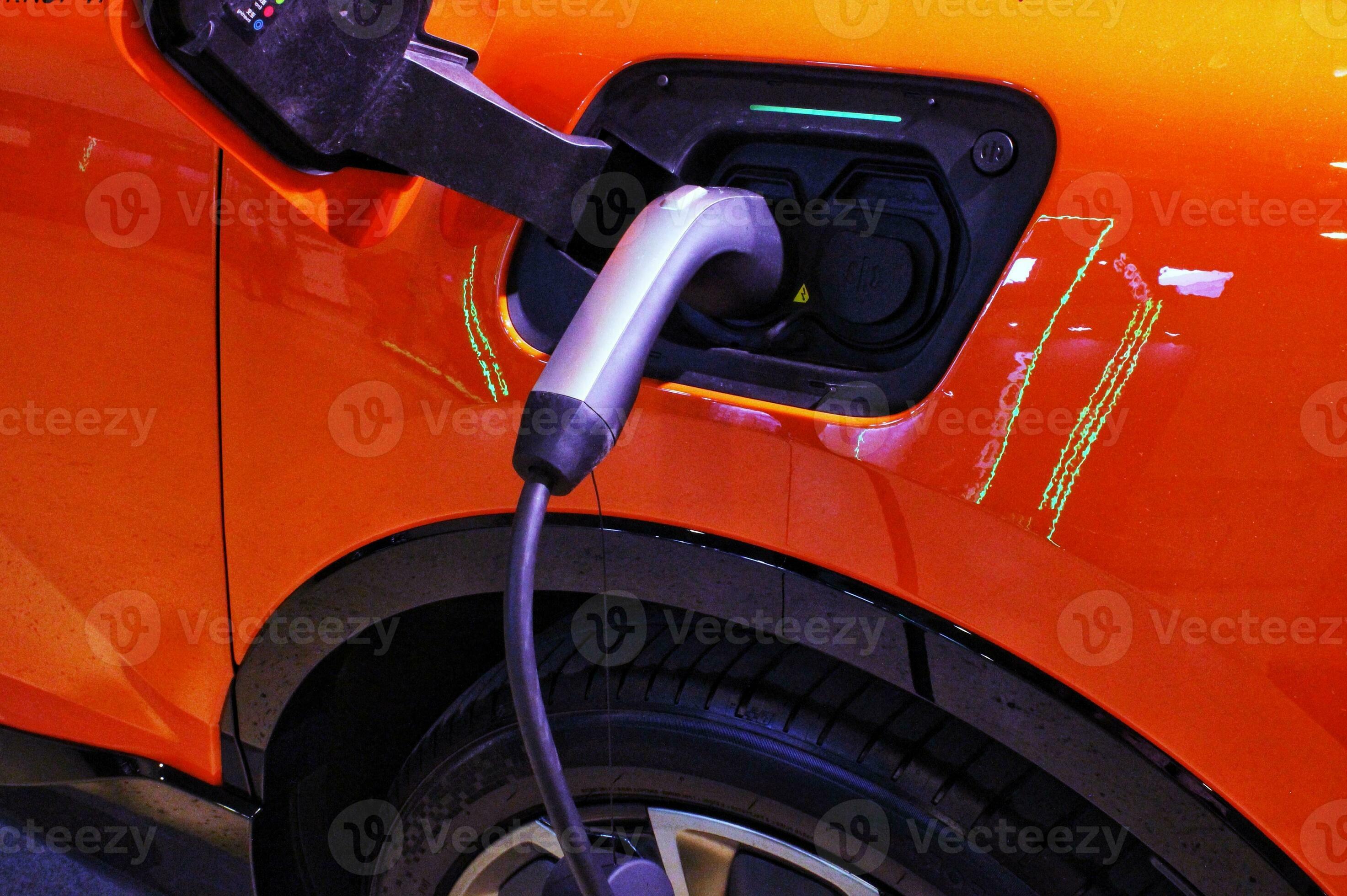 Electric vehicle charging station with power cable supply plugged station. Eco-friendly power ...