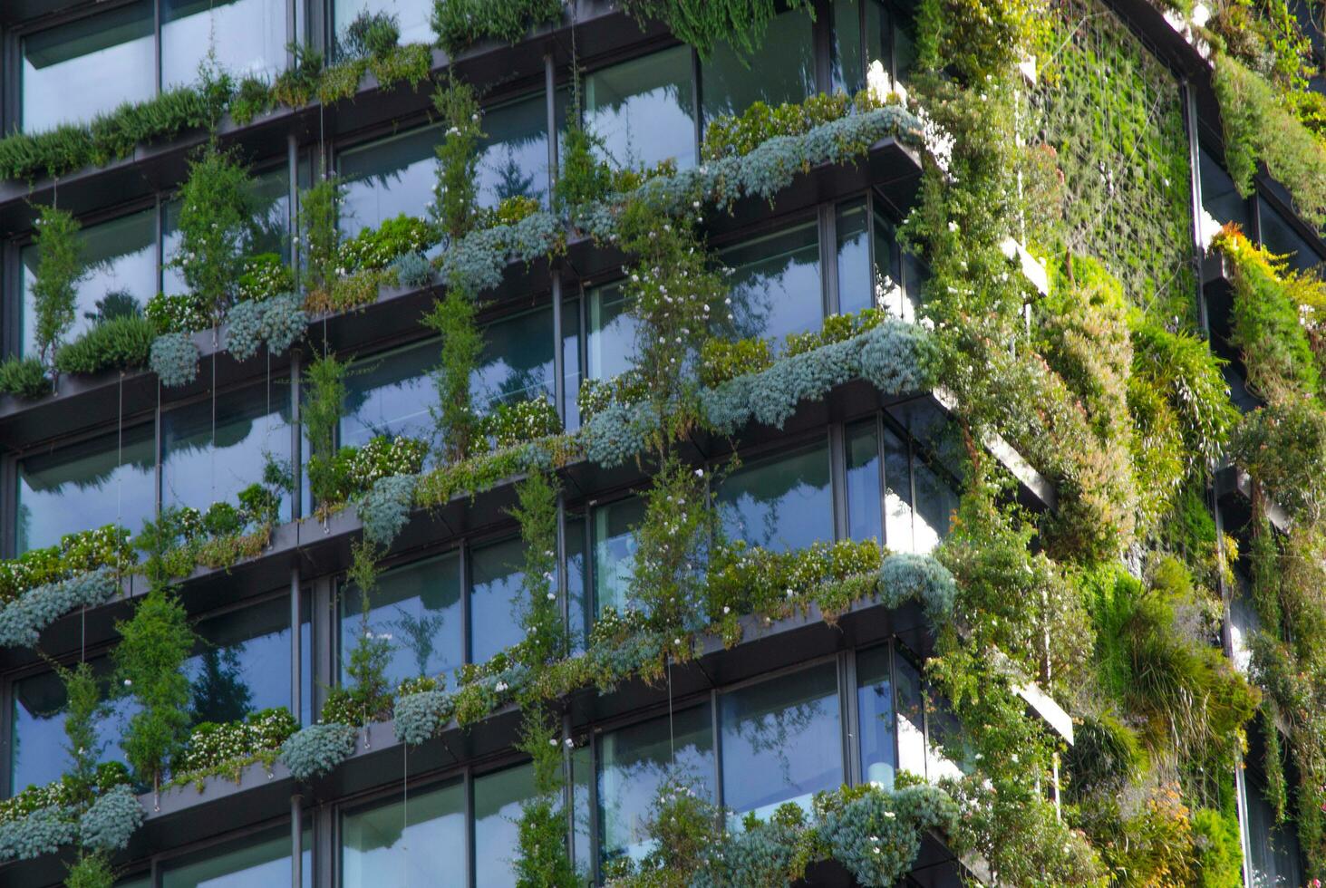 Greenery exterior glass window building full of plants, Green architecture is a style of ...