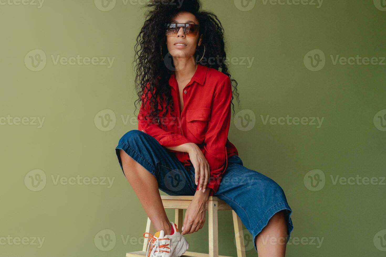 Attractive Black African American Woman In Stylish Outfit On Green