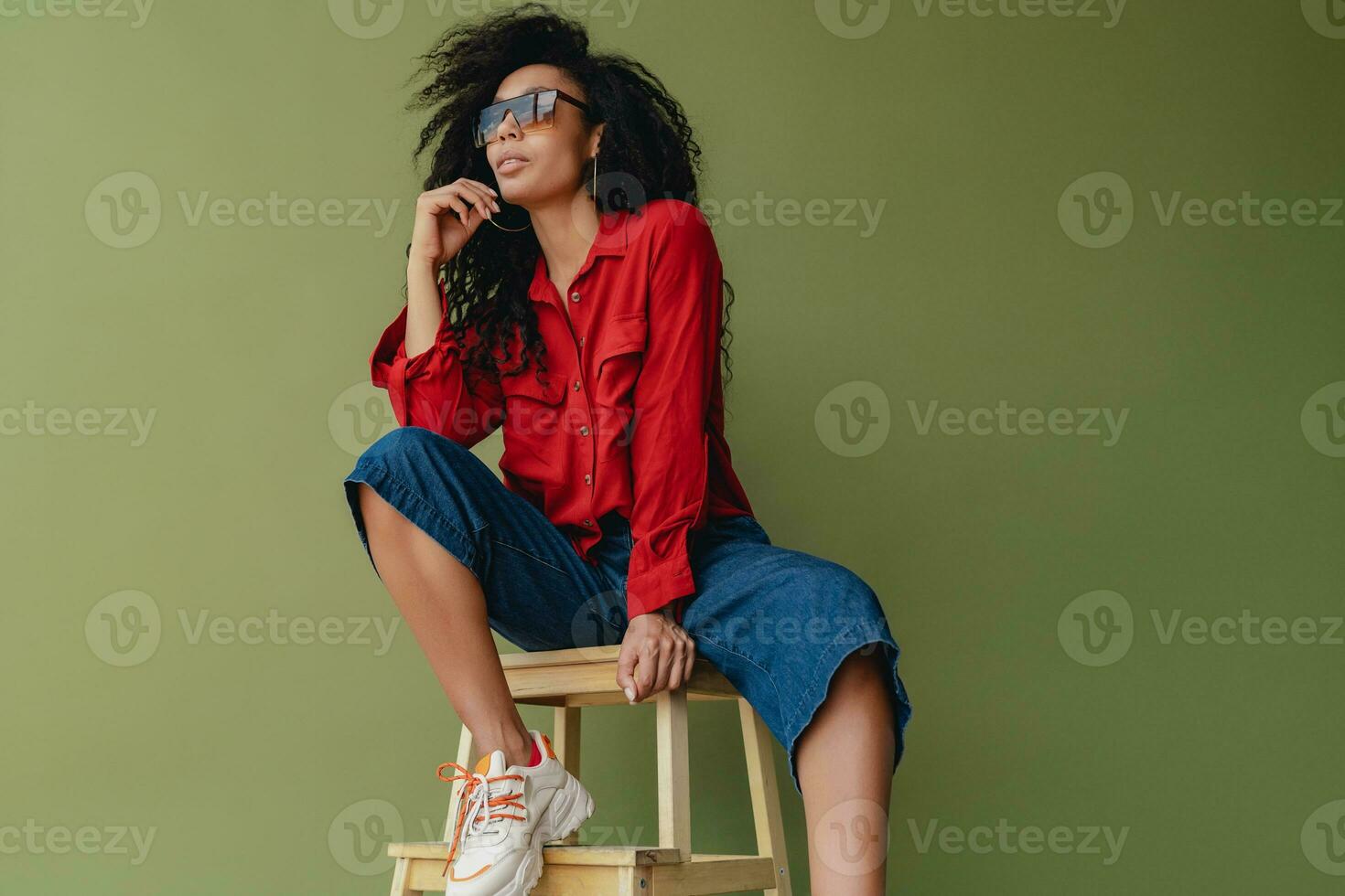 Attractive Black African American Woman In Stylish Outfit On Green