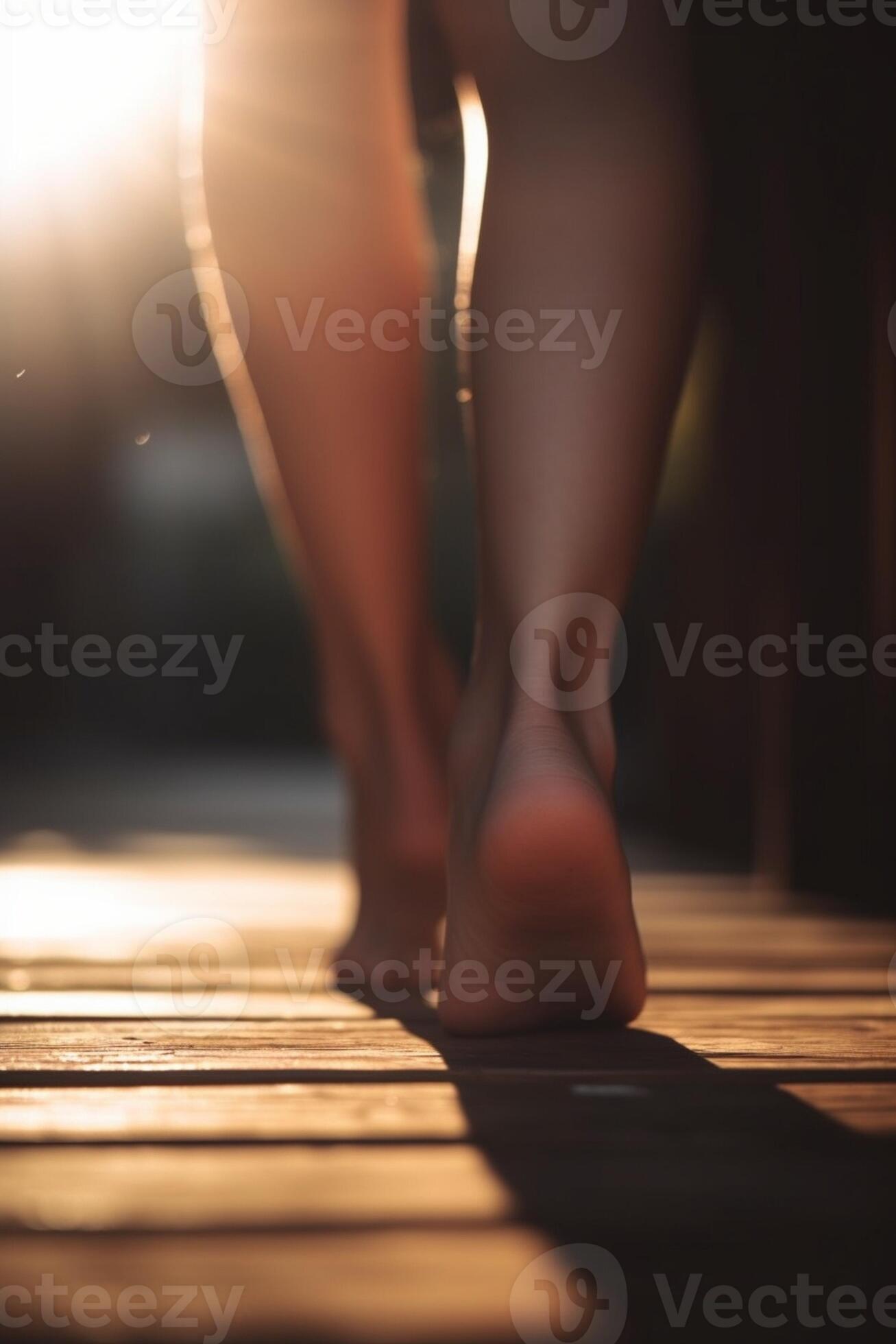 Taking Care Of Her Feet Closeup Of Young Woman Touching Her Feet While Standing On Hardwood