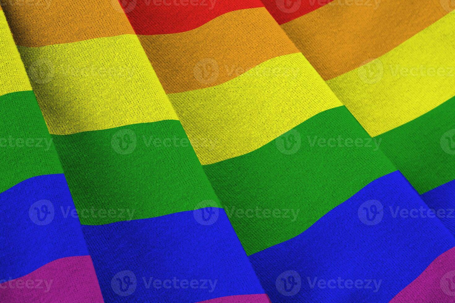 LGBT community flag with big folds waving close up under the studio ...