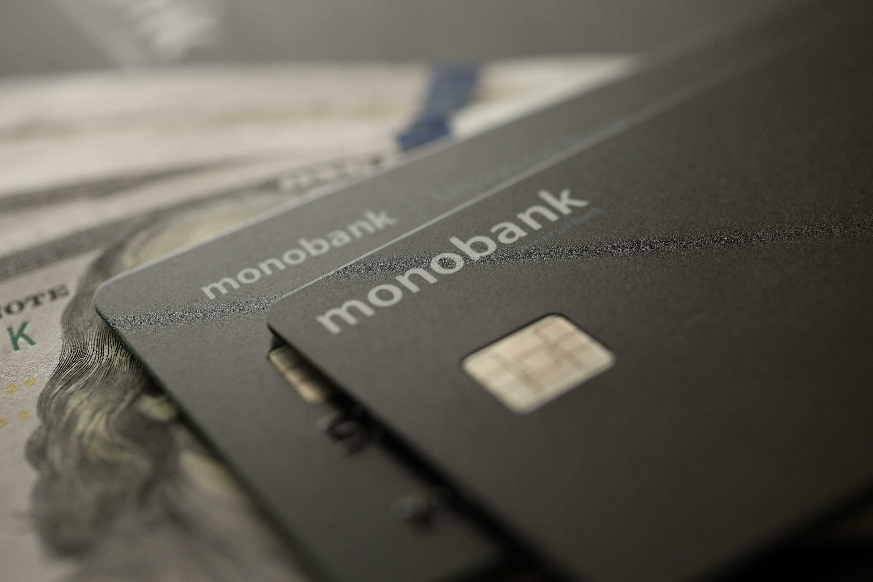 KYIV, UKRAINE - JULY 7, 2023 Monobank banking plastic cards with money on table 29612547 Stock ...
