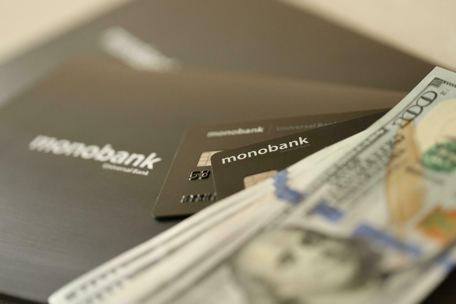 KYIV, UKRAINE - JULY 7, 2023 Monobank banking plastic cards with money on table 29612936 Stock ...