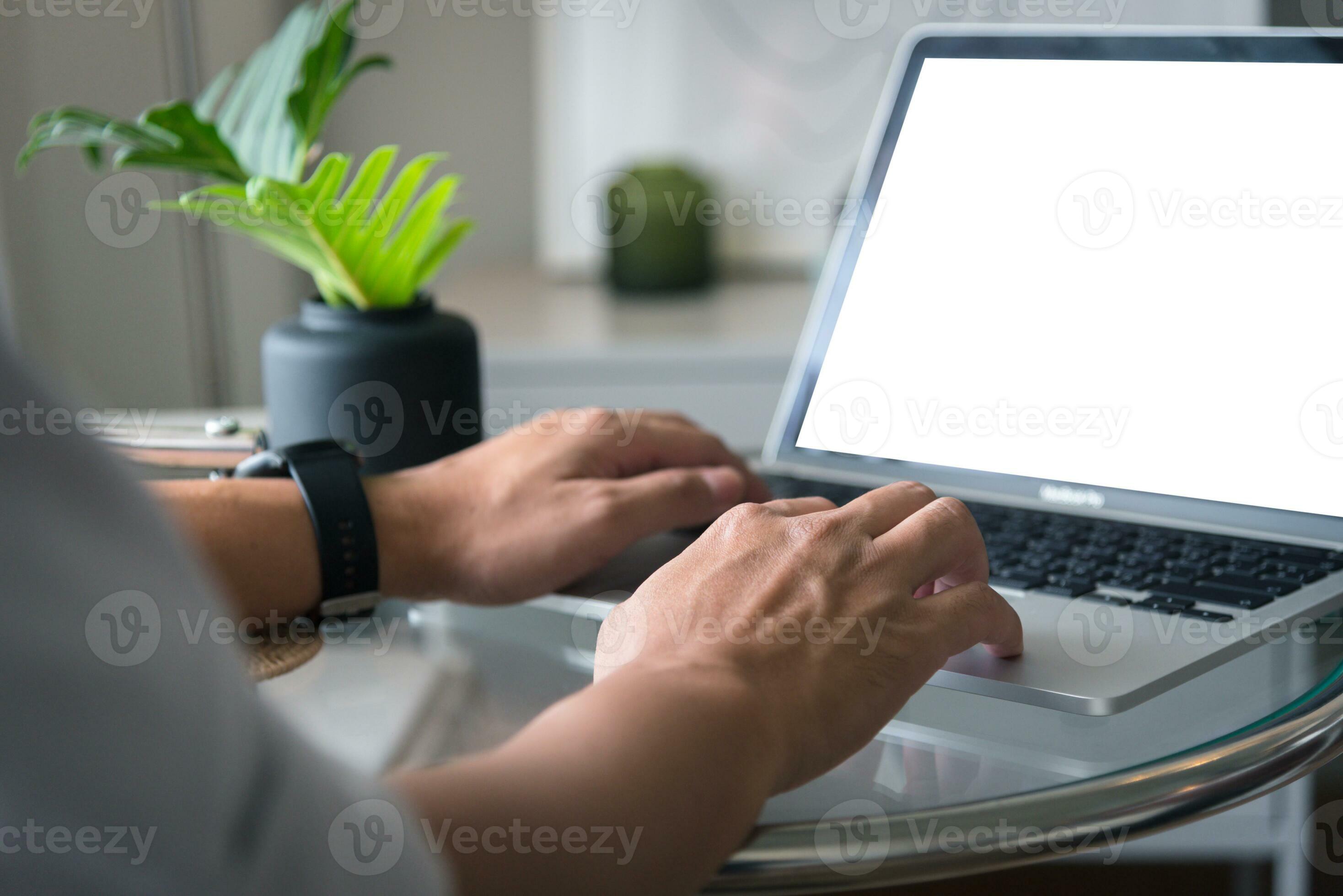 man using and typing on laptop computer mockup with blank screen ...