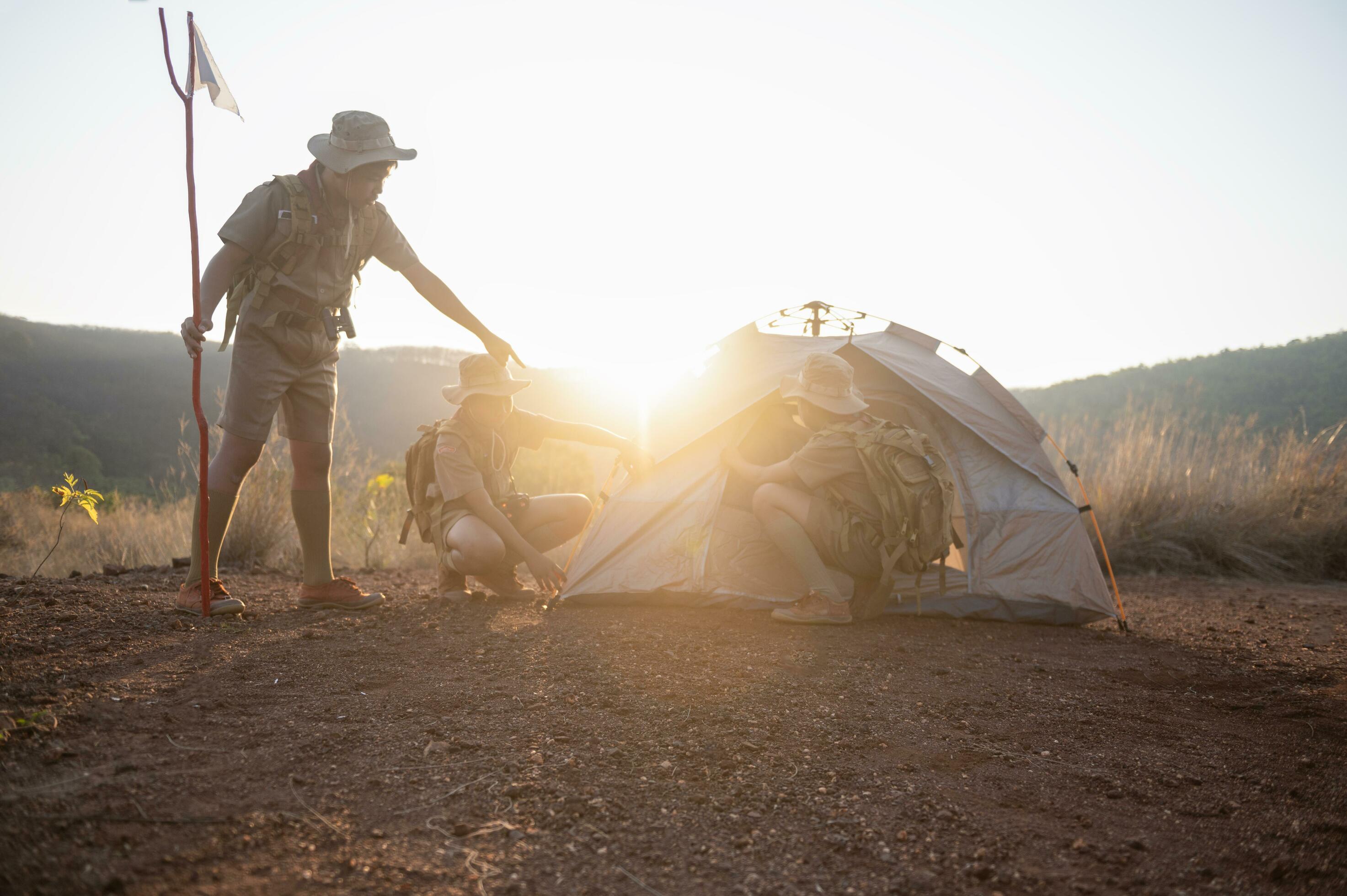 Boy Scouts team climbing with backpacks standing on mountain Boy Scouts rejoice at rock climbing ...