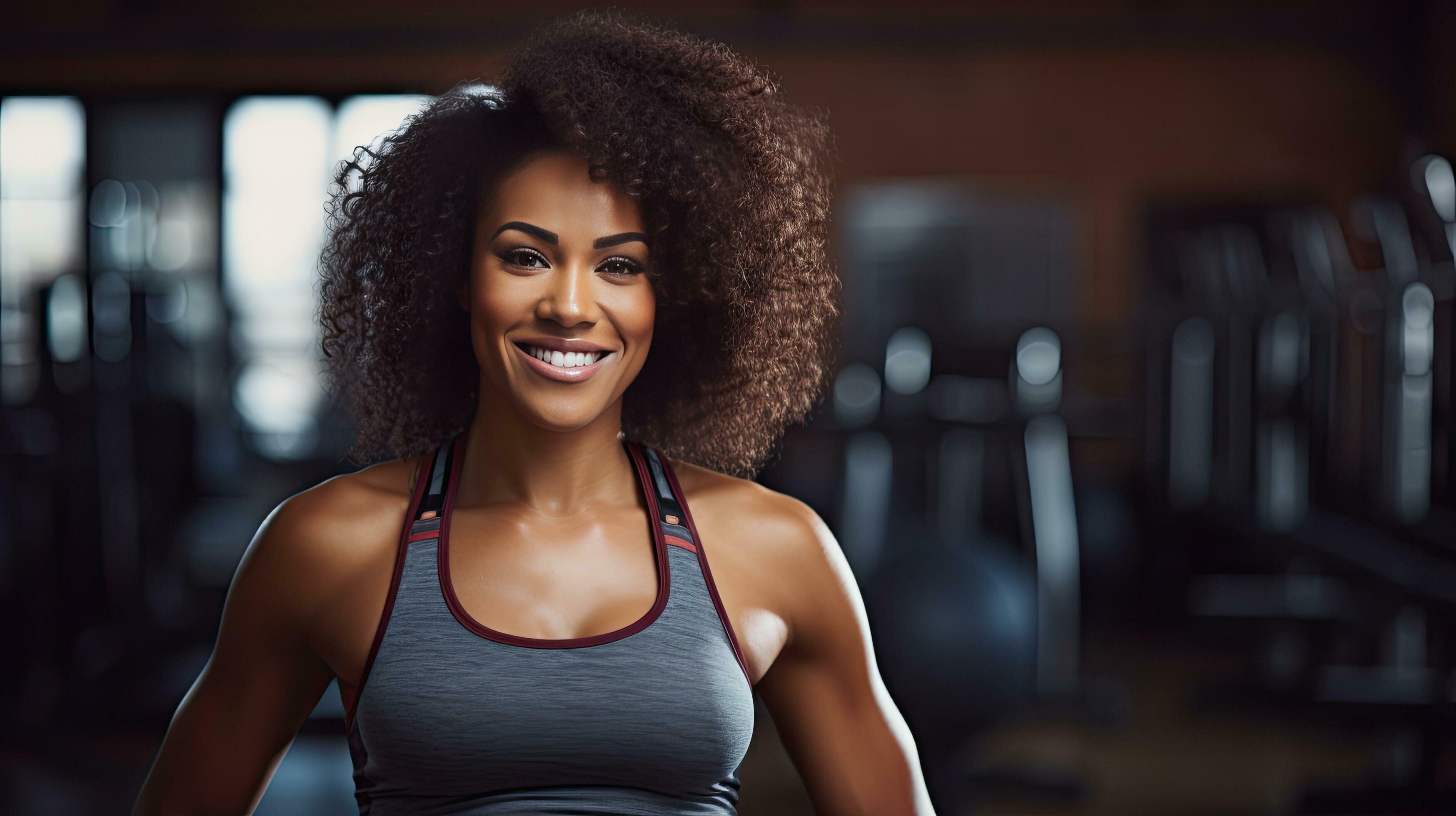 Black woman fitness, beautiful Afro-American woman with curly hair in the gym African fitness ...