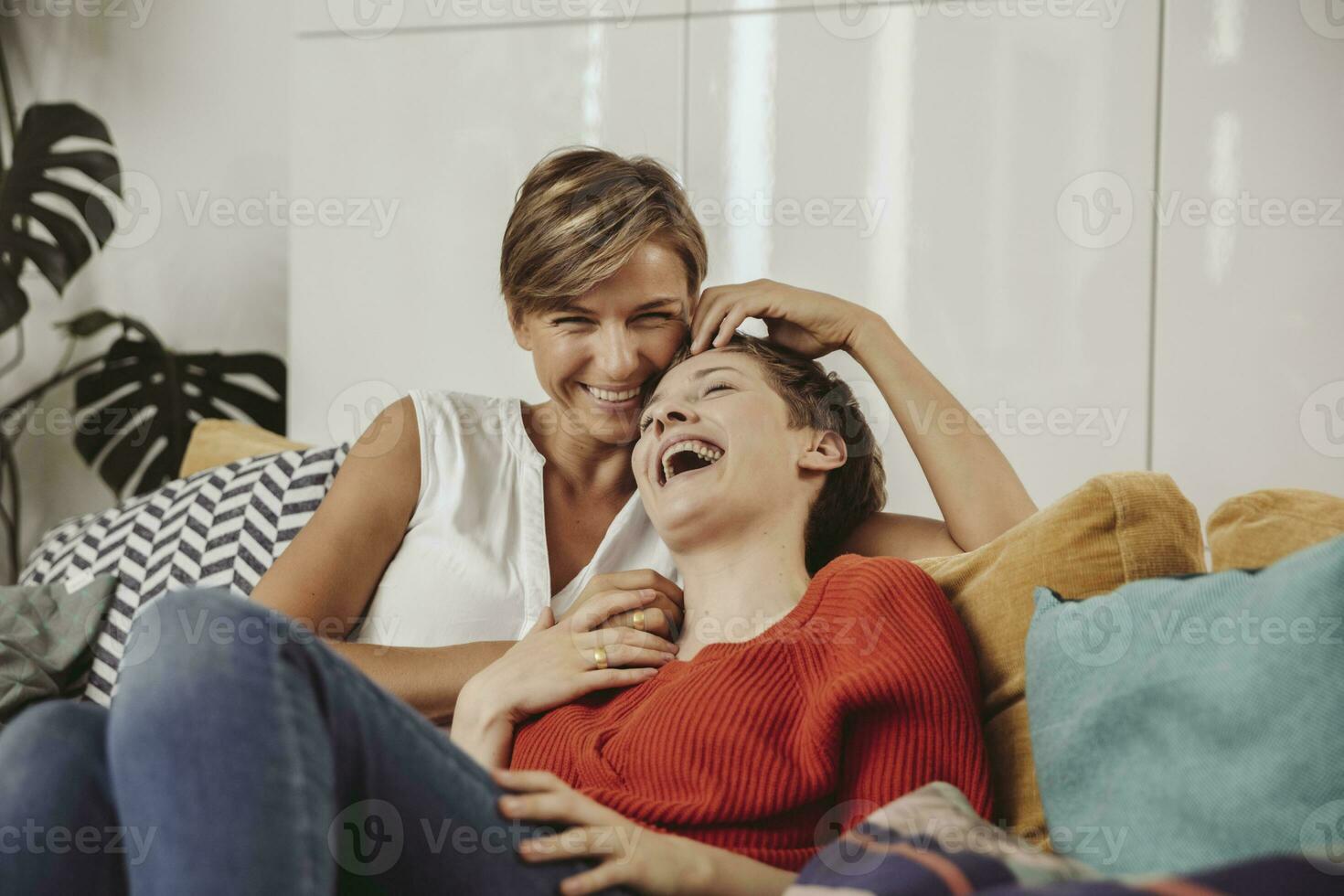 Happy Lesbian Couple Laughing And Cuddling On Couch 29824042 Stock