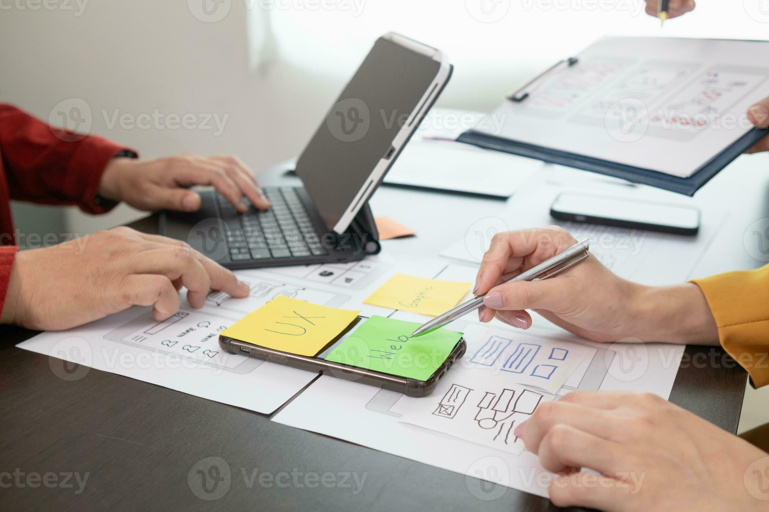 team of UI UX web designer are working together to develop mobile ...