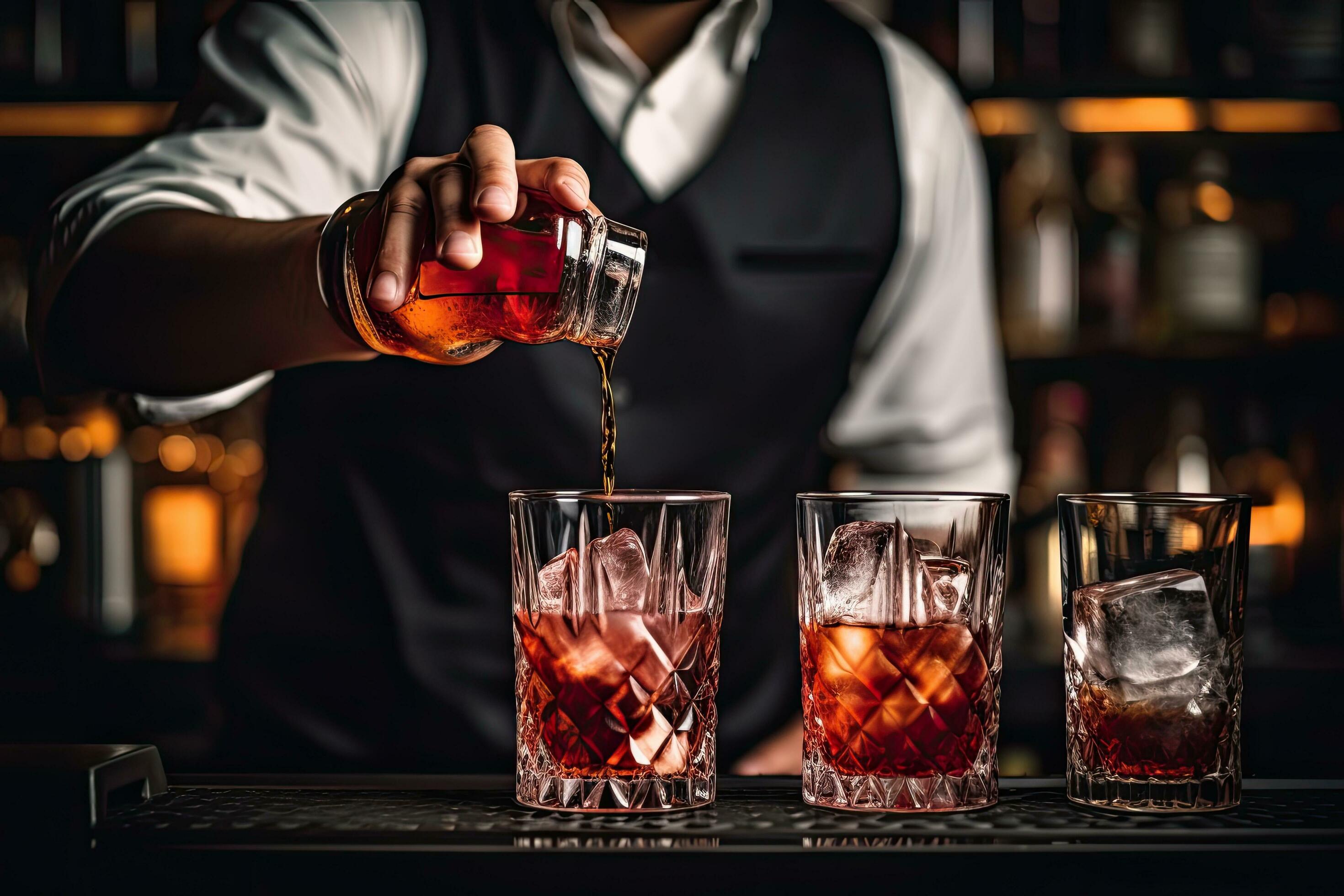 Bartender pouring drink into glass with ice cubes at bar counter, Bartender pouring and serving ...