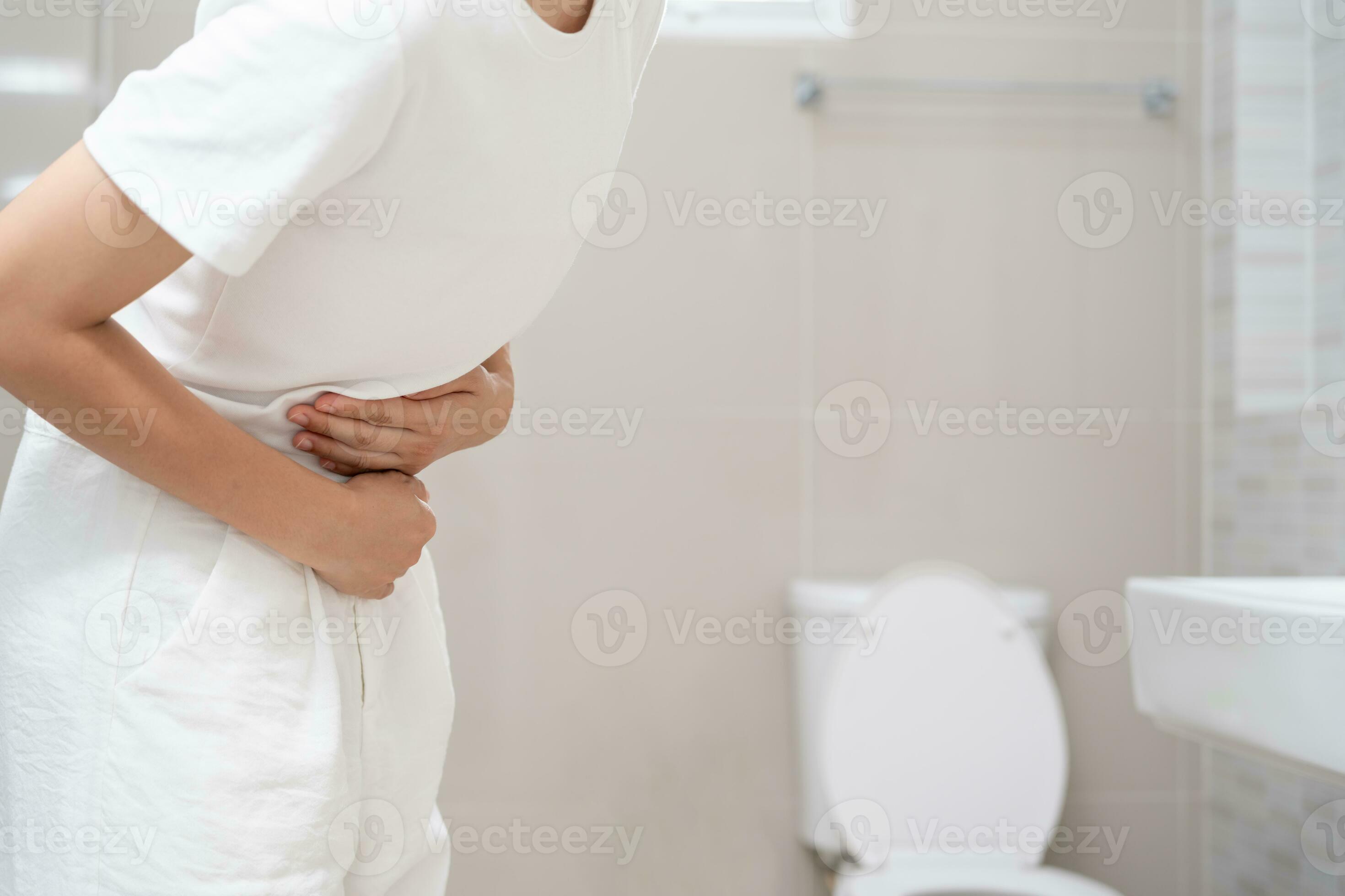 Constipation and diarrhea in bathroom. Hurt woman touch belly stomach ache painful. colon ...