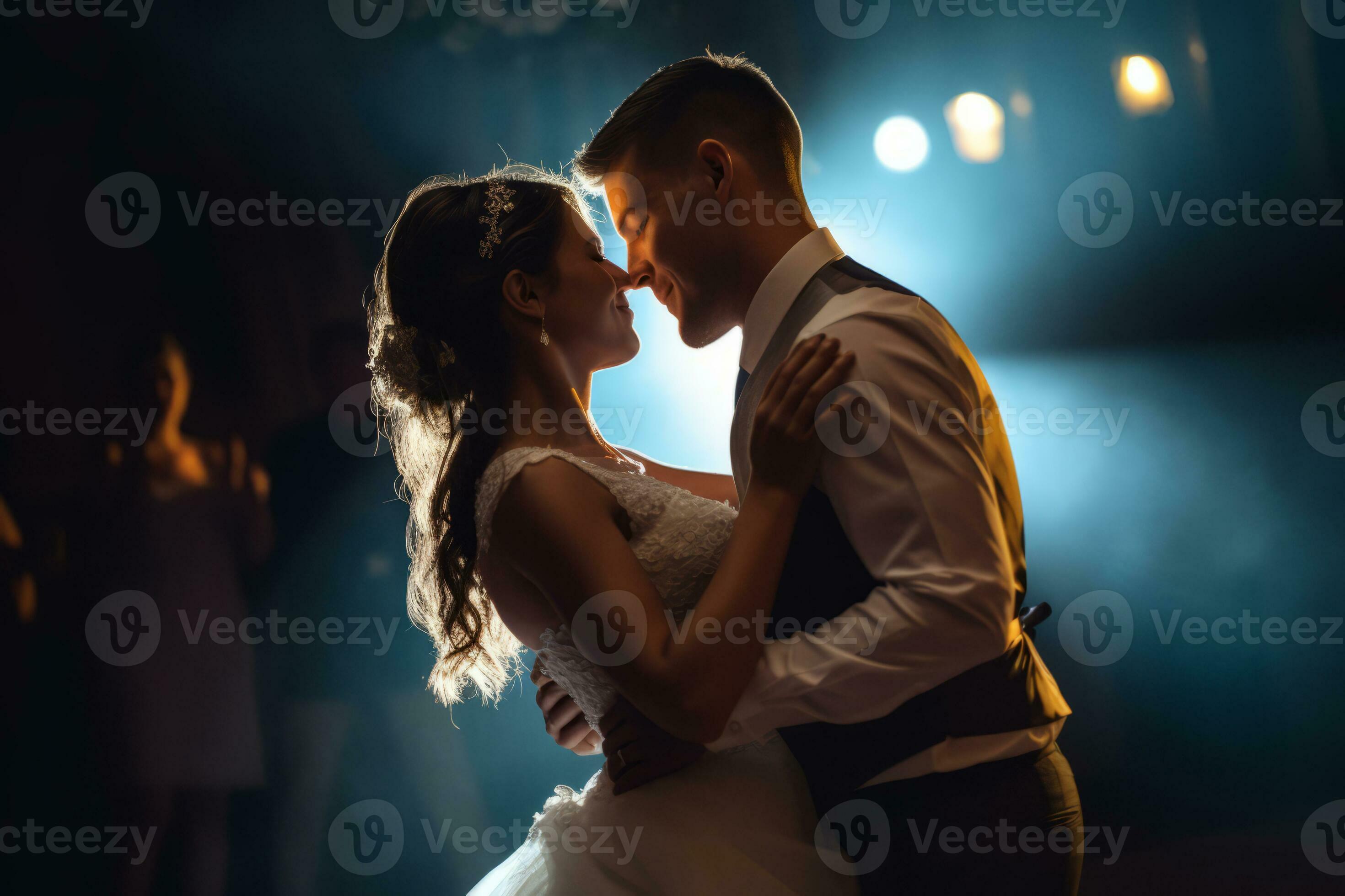 Couple sharing an intimate moment during their first dance on a dimly lit dance floor, capturing ...
