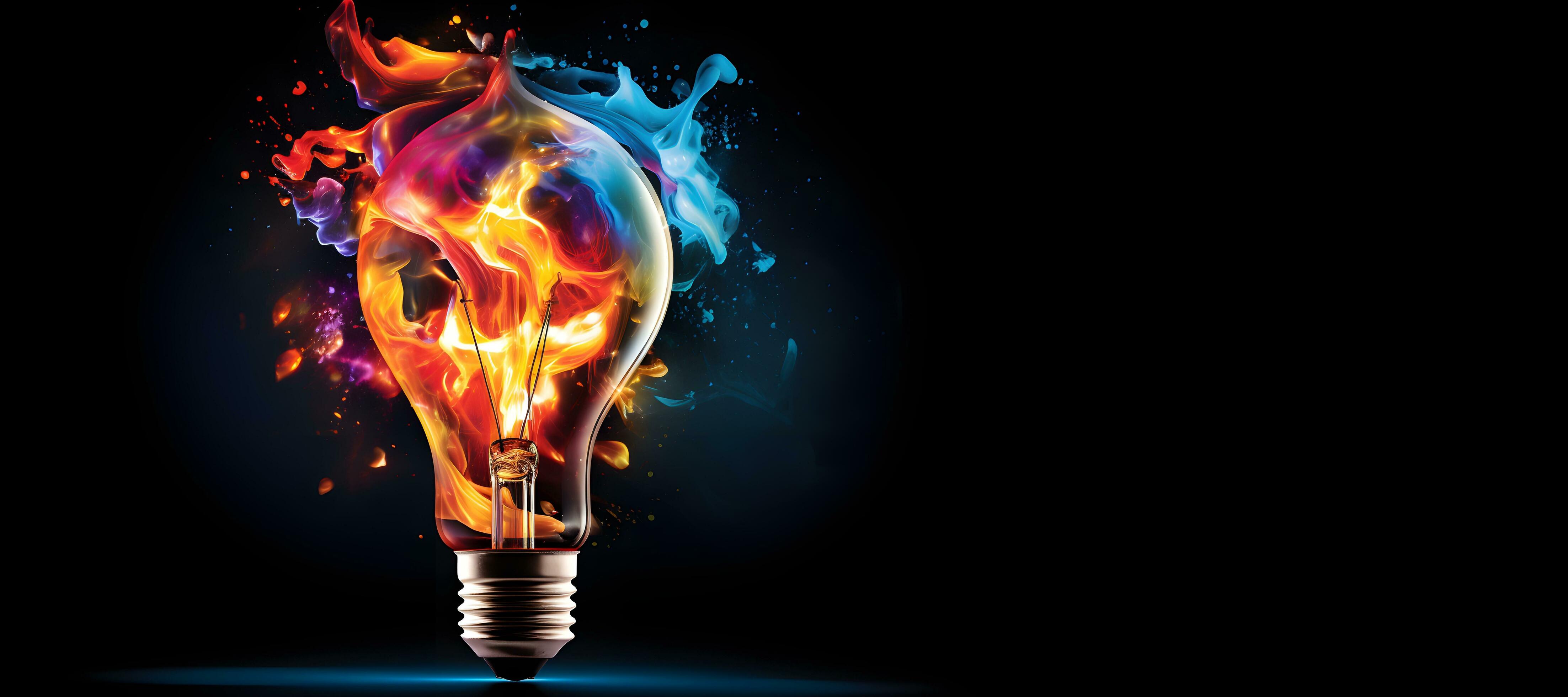 Creative light bulb explodes with colorful paint and splashes on a dark ...