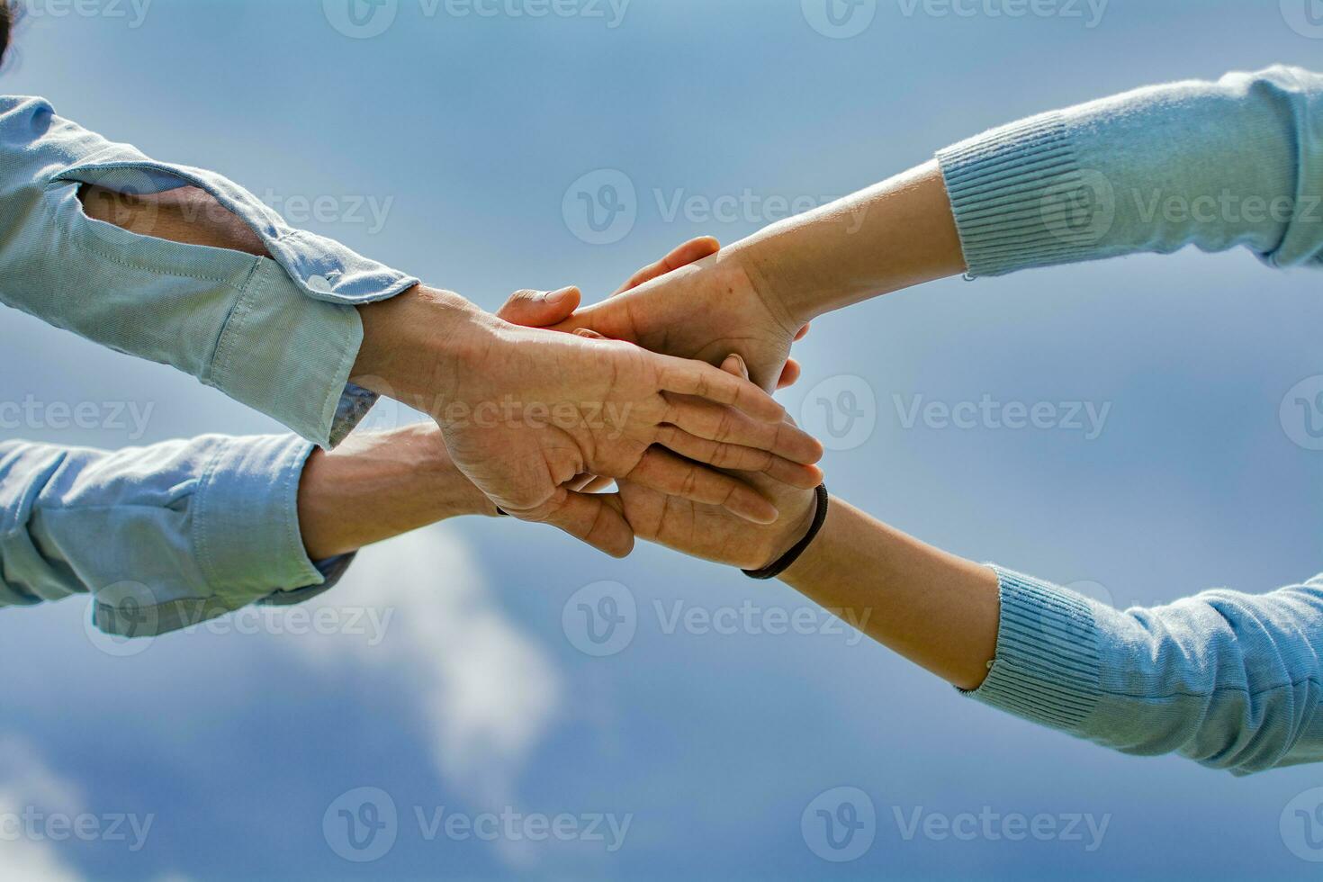 Concept of one hand over another forming a team, Concept of unity with ...