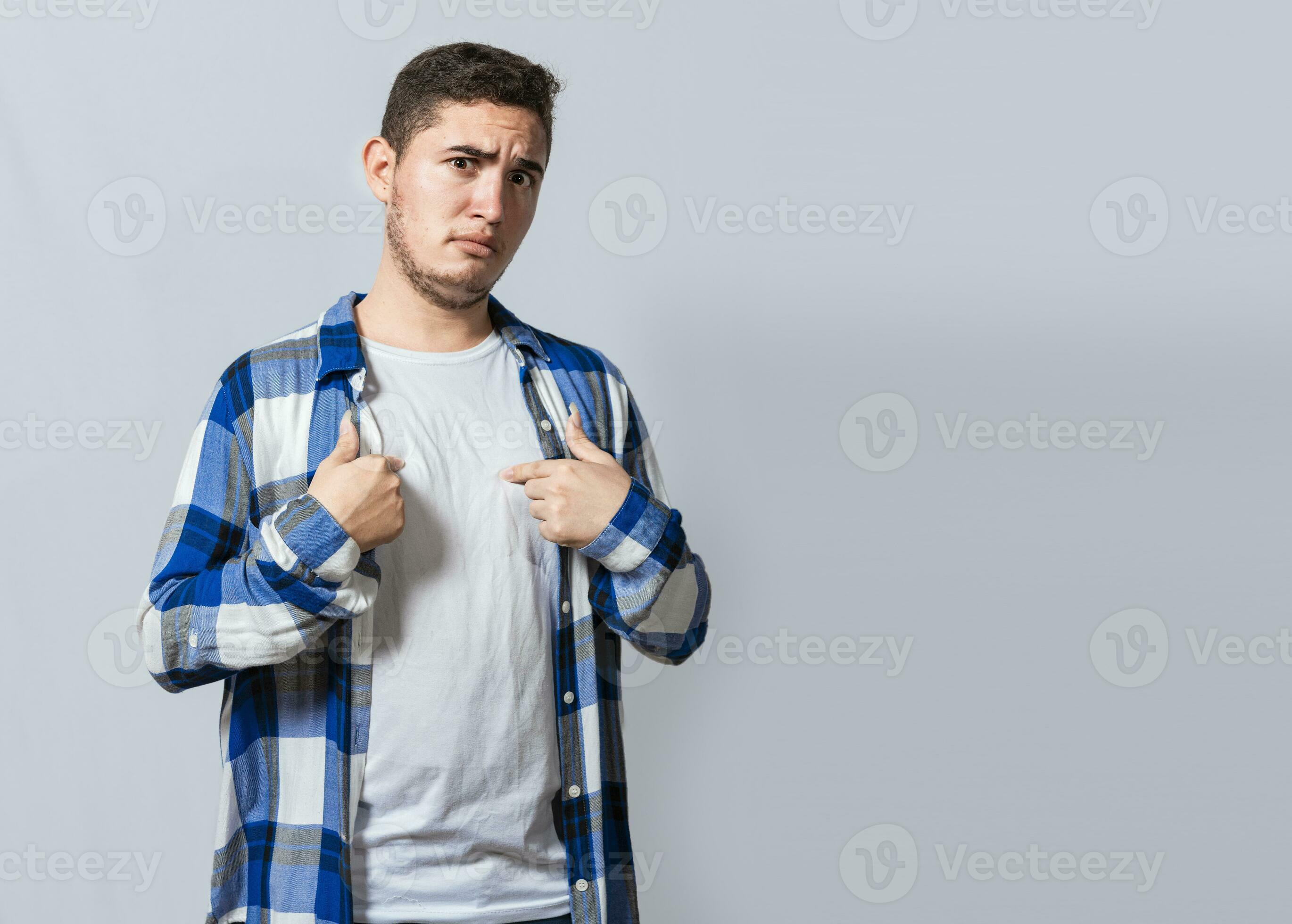 Confused caucasian young man pointing at himself. Confused person ...