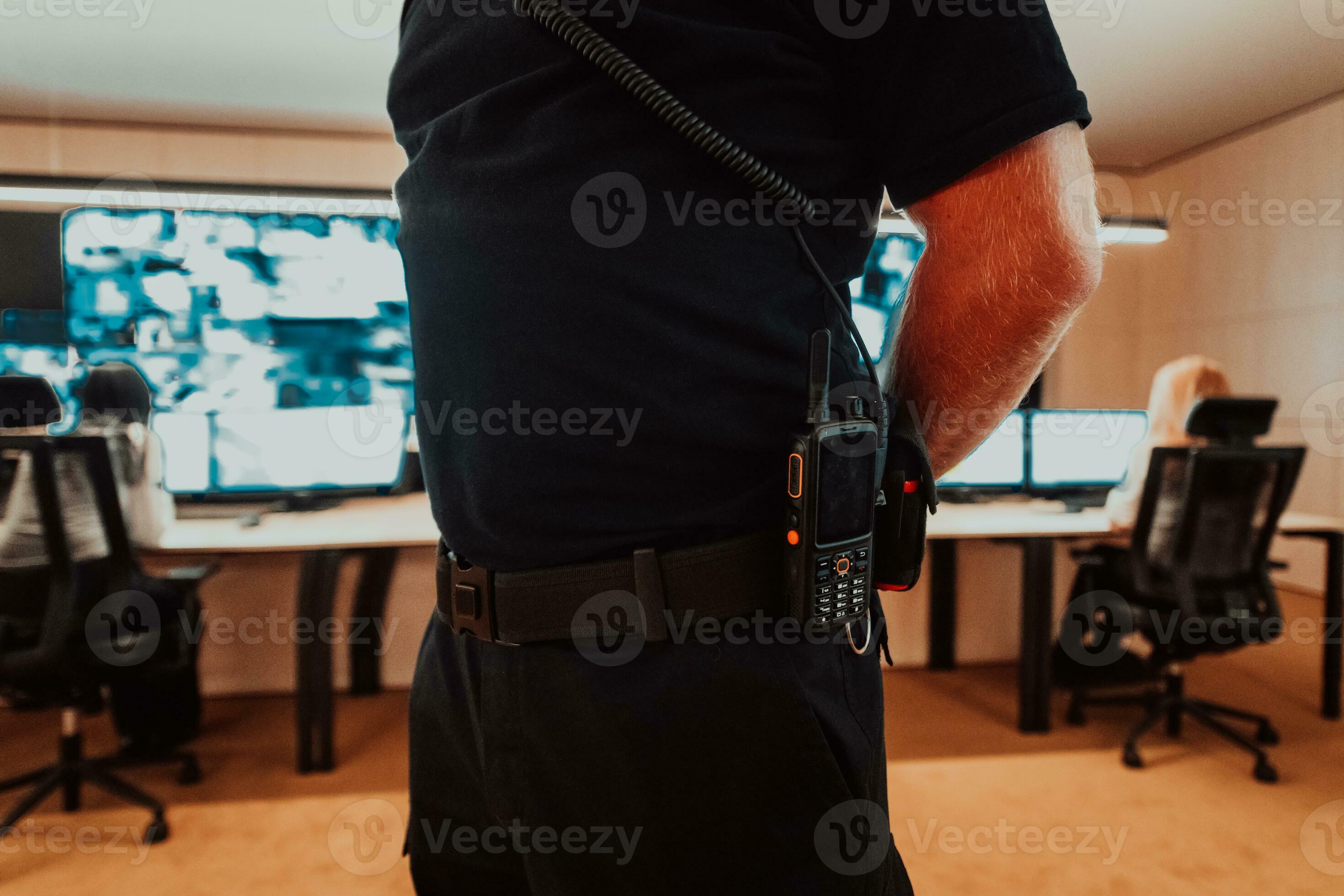 Male security operator working in a data system control room offices ...