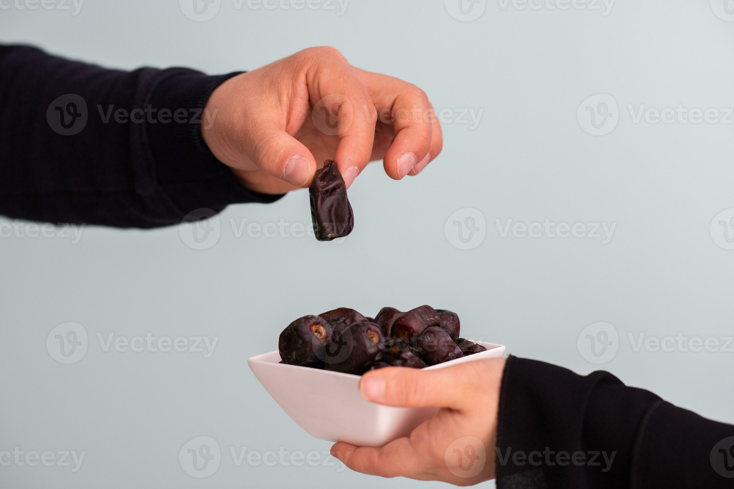 Modern Muslim Woman Holding A Plate Full Of Sweet Dates On Iftar Time