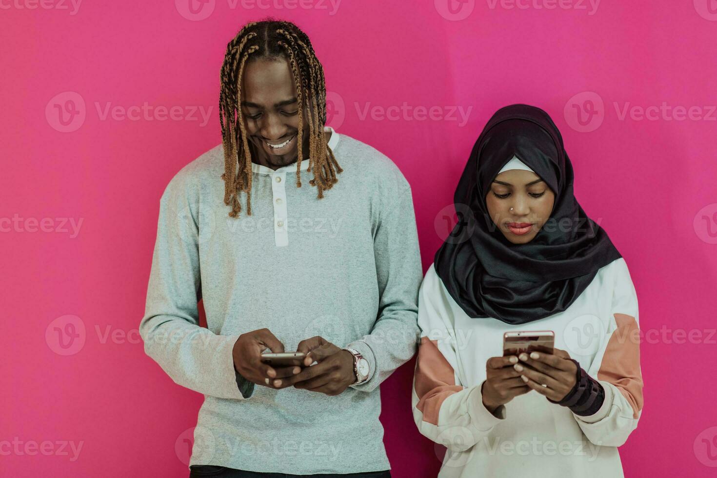 Young African American Couple Laughing Using Smartphones Apps Isolated