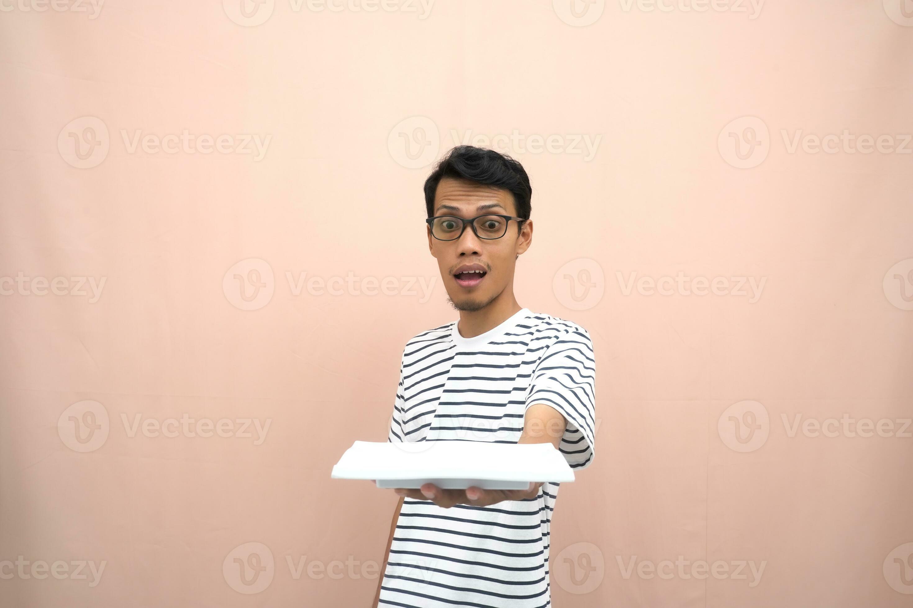 portrait of an asian man in glasses wearing a casual striped t-shirt ...