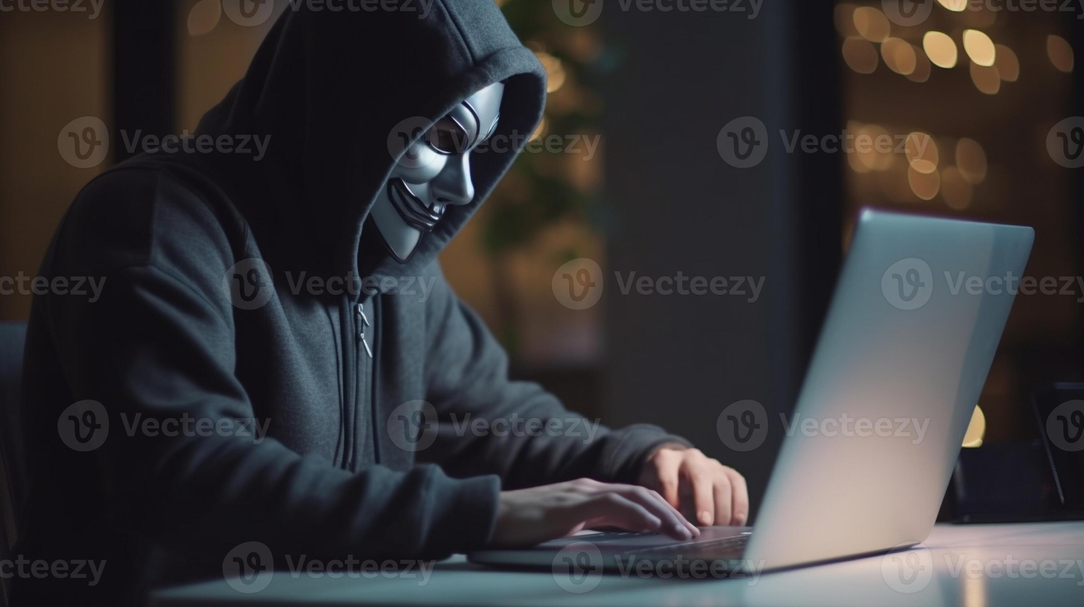 Portrait Of Unrecognizable Young Hacker In Black Mask Using Laptop