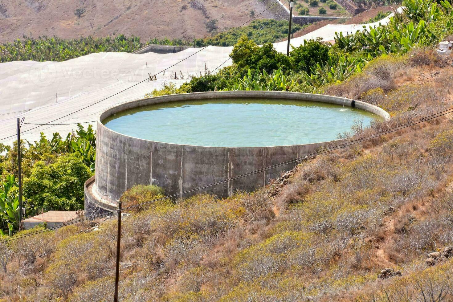 a concrete water tank on a hillside 31213880 Stock Photo at Vecteezy