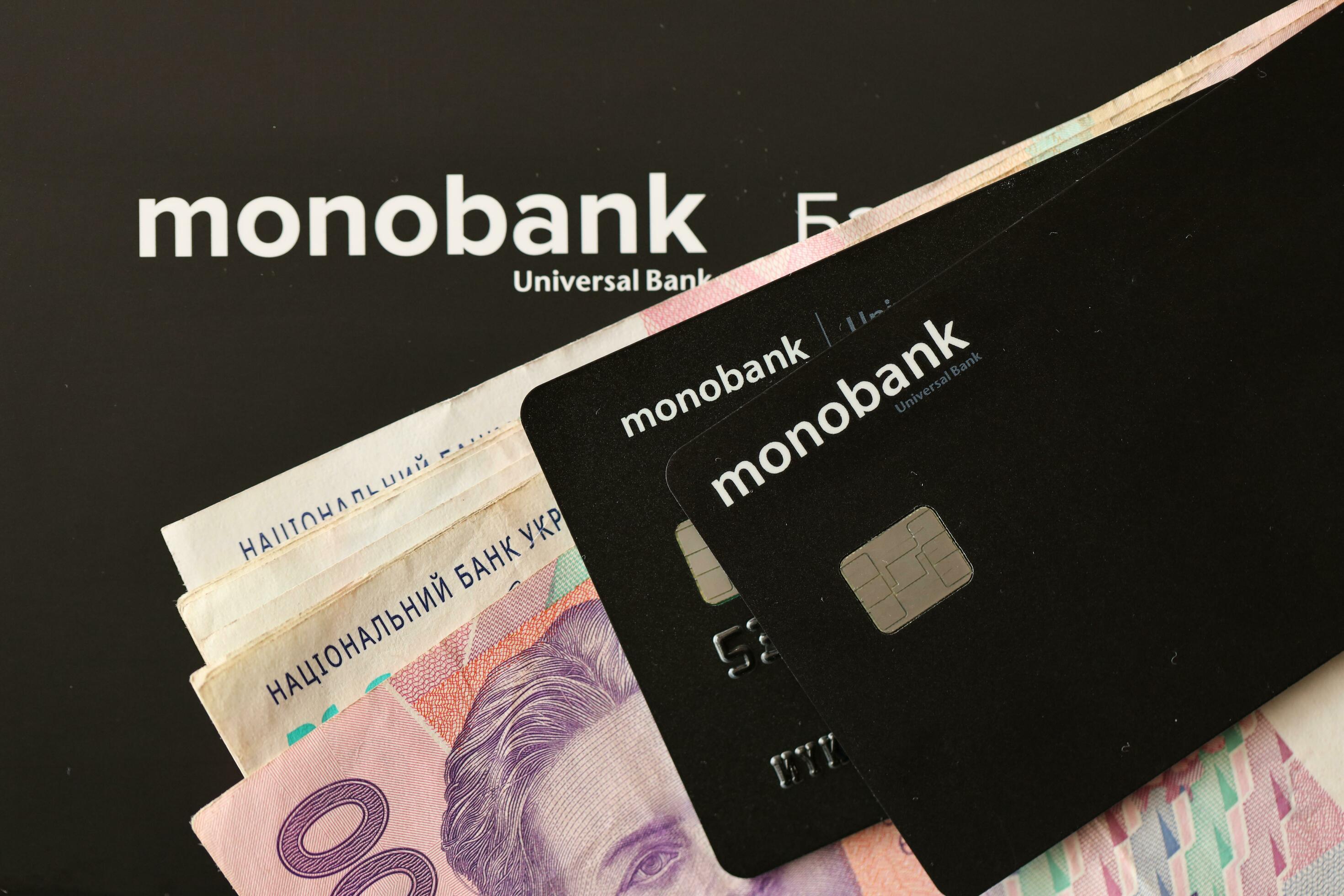 KYIV, UKRAINE - JULY 7, 2023 Monobank banking plastic cards with money on table 31234723 Stock ...