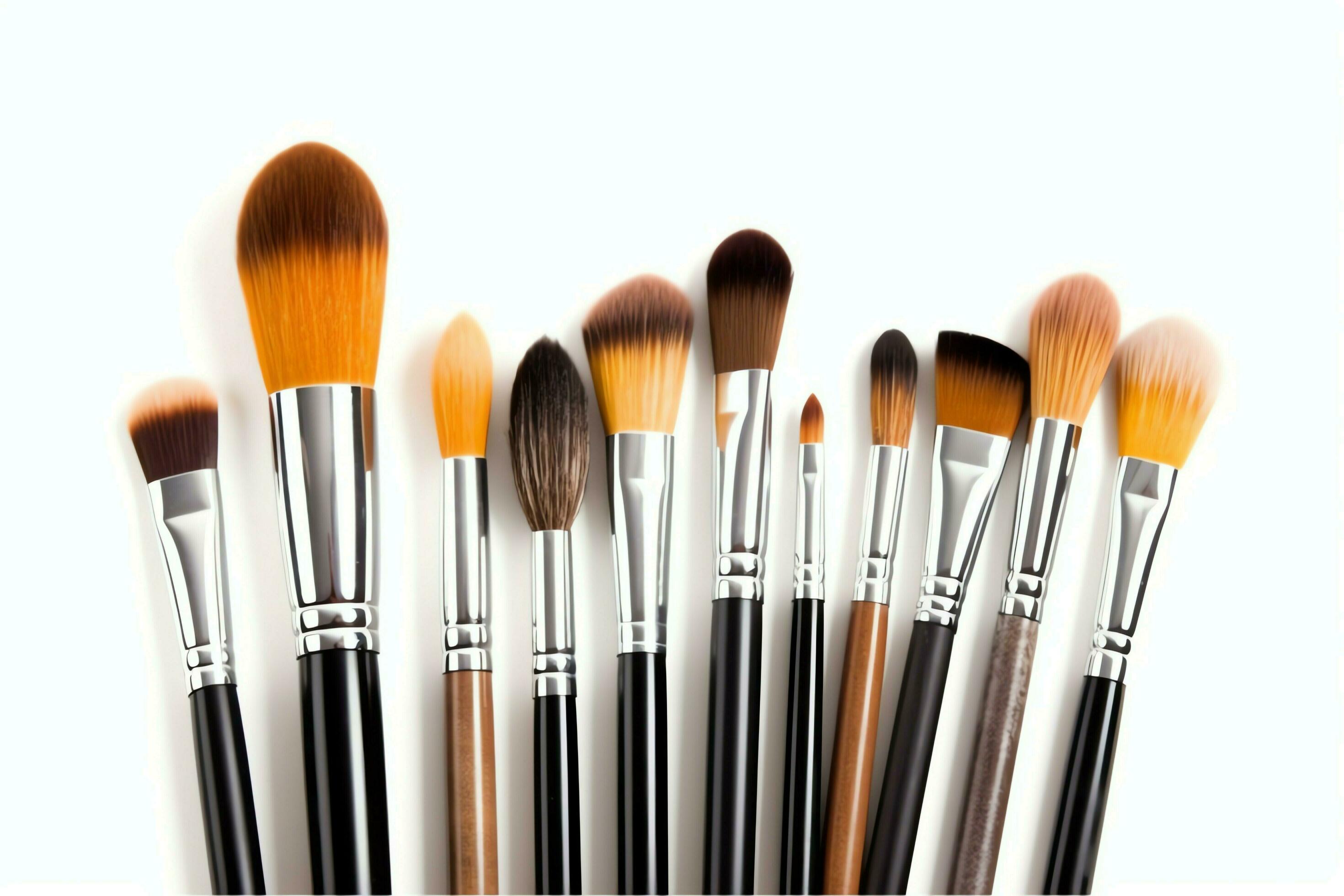Set of professional makeup brushes cosmetic accessories set on white background. Makeup tool ...