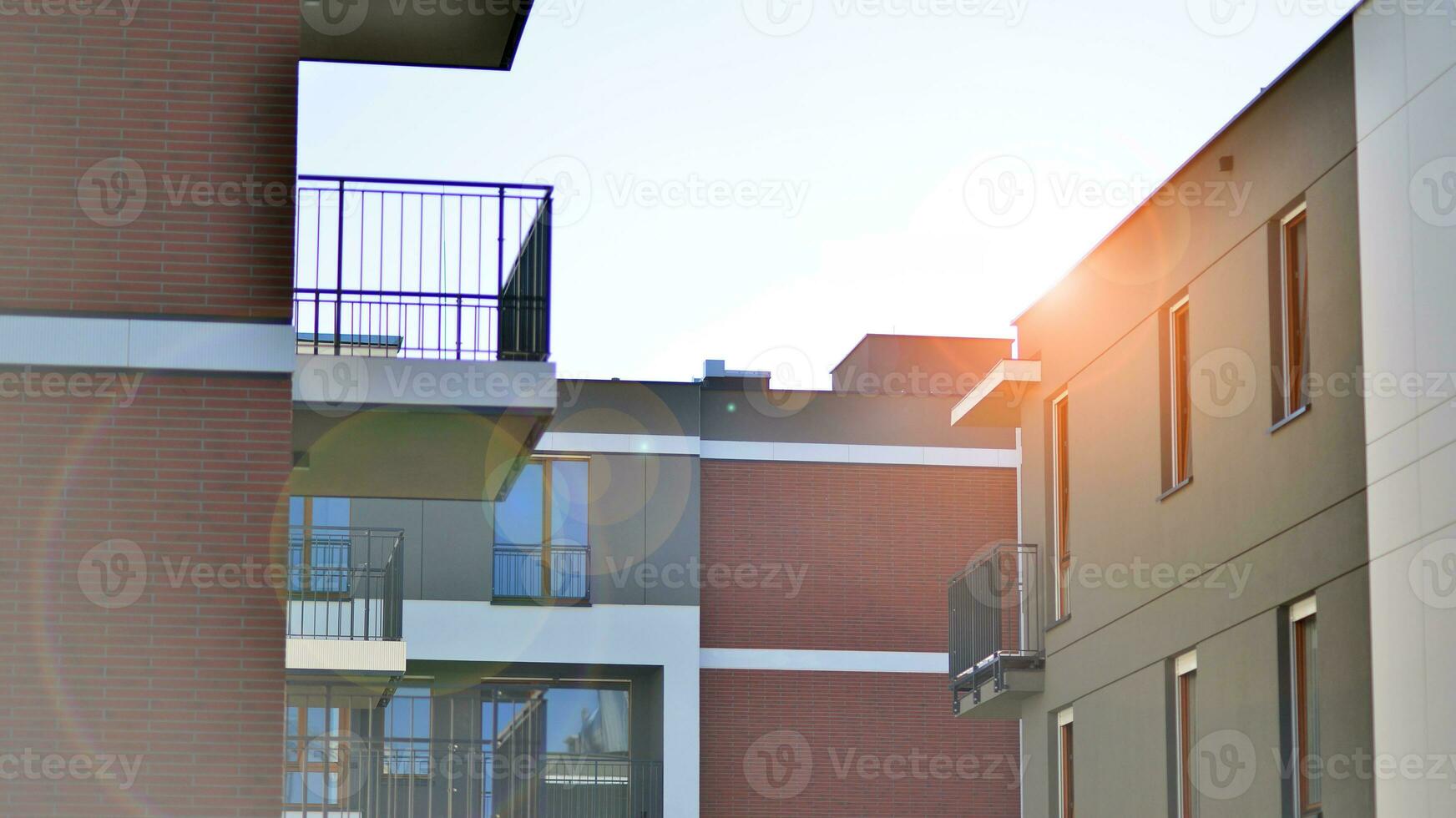 Brand new apartment building on sunny day. Modern residential ... Brand new apartment building on sunny day. Modern residential ...