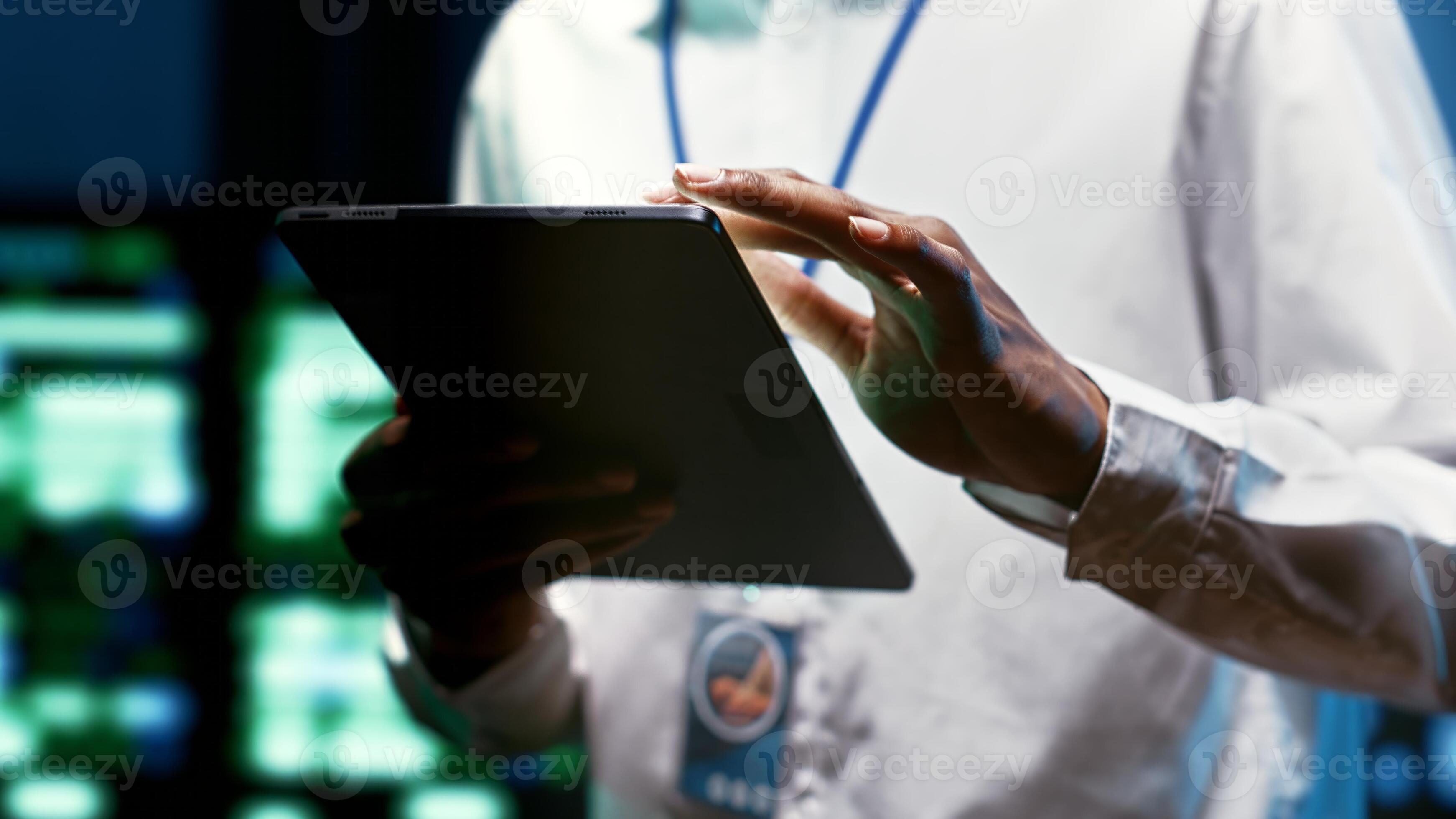 System Administrator Using Tablet To Check High Tech Facility Security