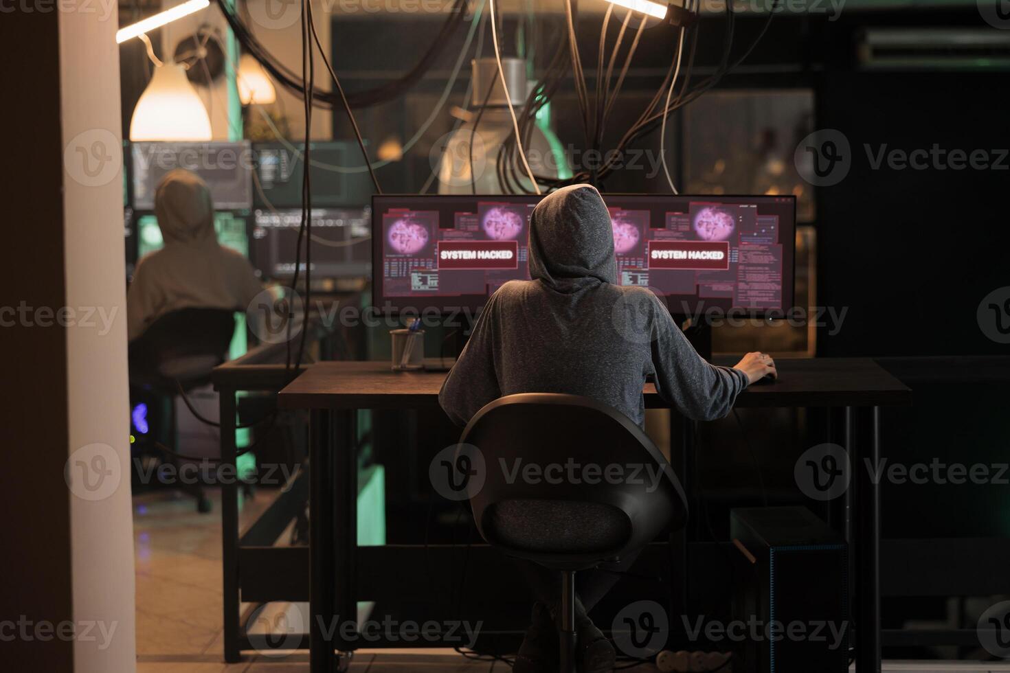 Young thief working to hack computer system on multi monitors, using server malware to plant ...