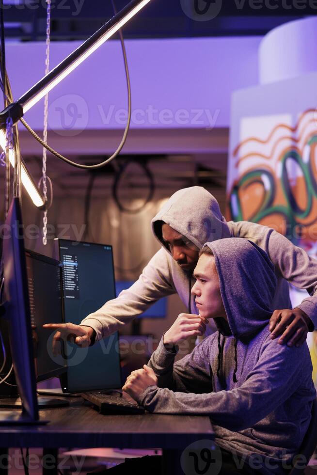 Confused hacker pointing at ransomware code mistake on screen. Criminal ...