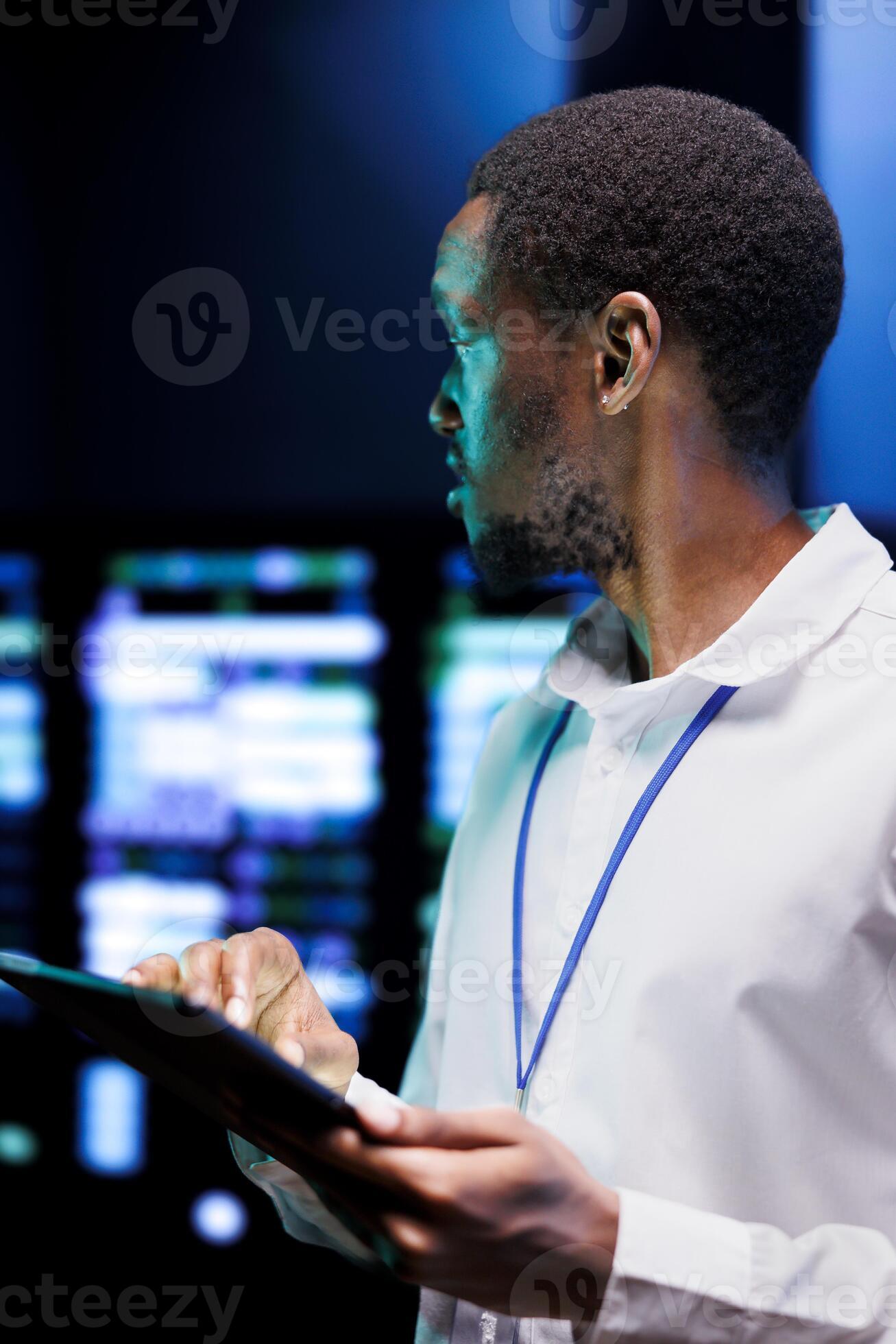 Adept System Administrator Using Tablet To Survey Energy Consumption Across Server Row