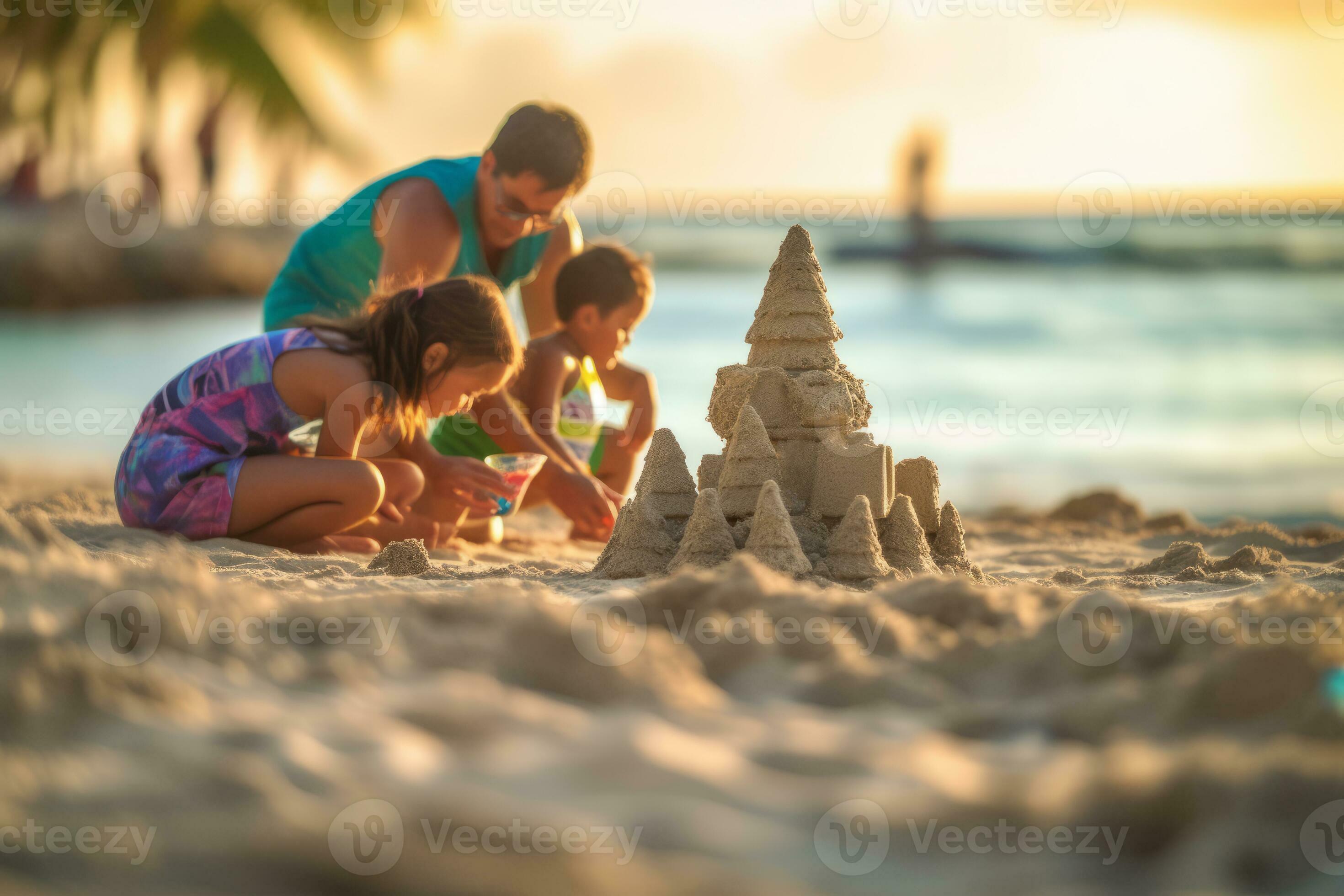 A family building sandcastles and playing in the shallow waves on a ...