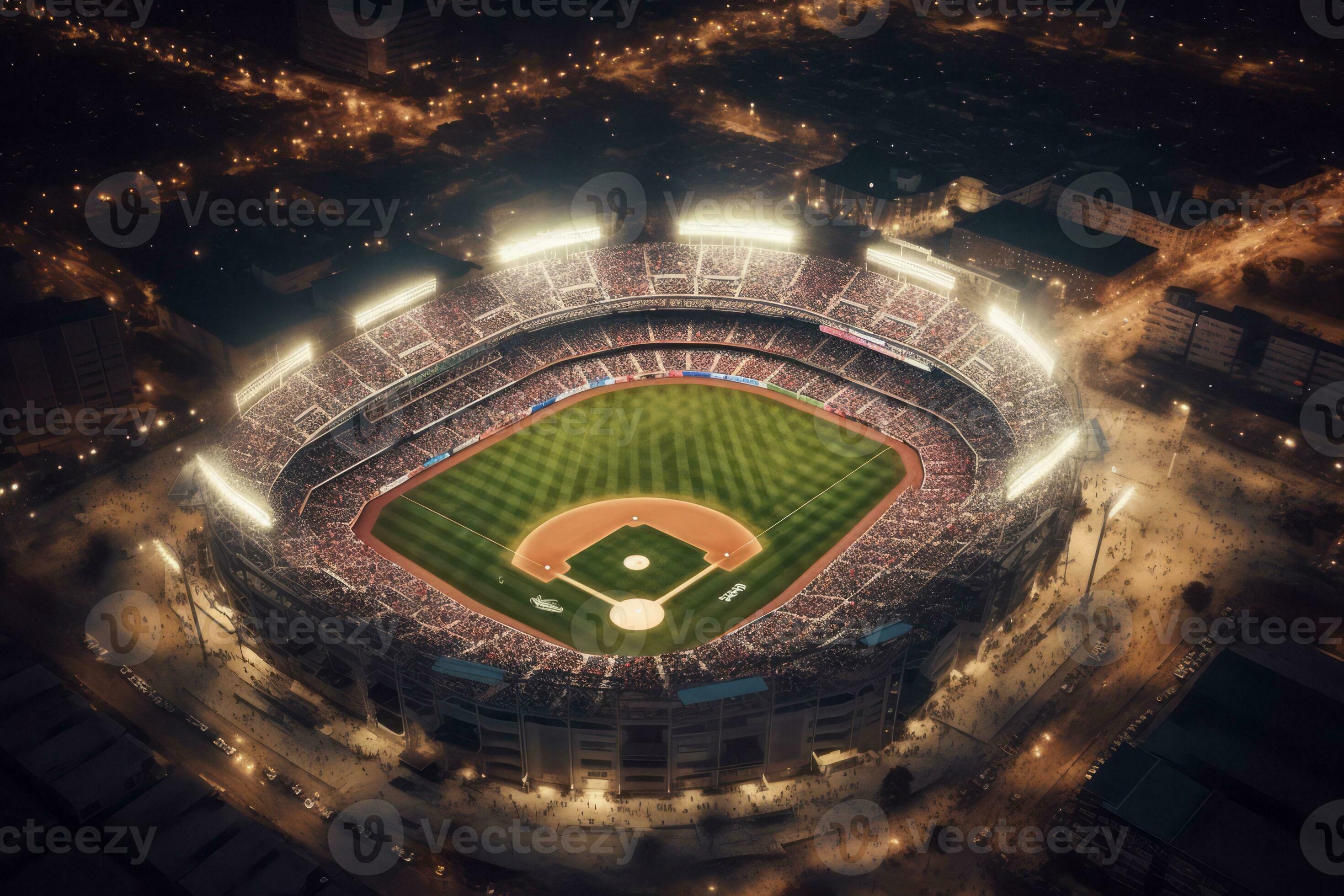 An aerial shot of a baseball stadium during a game, with the field illuminated by stadium lights ...