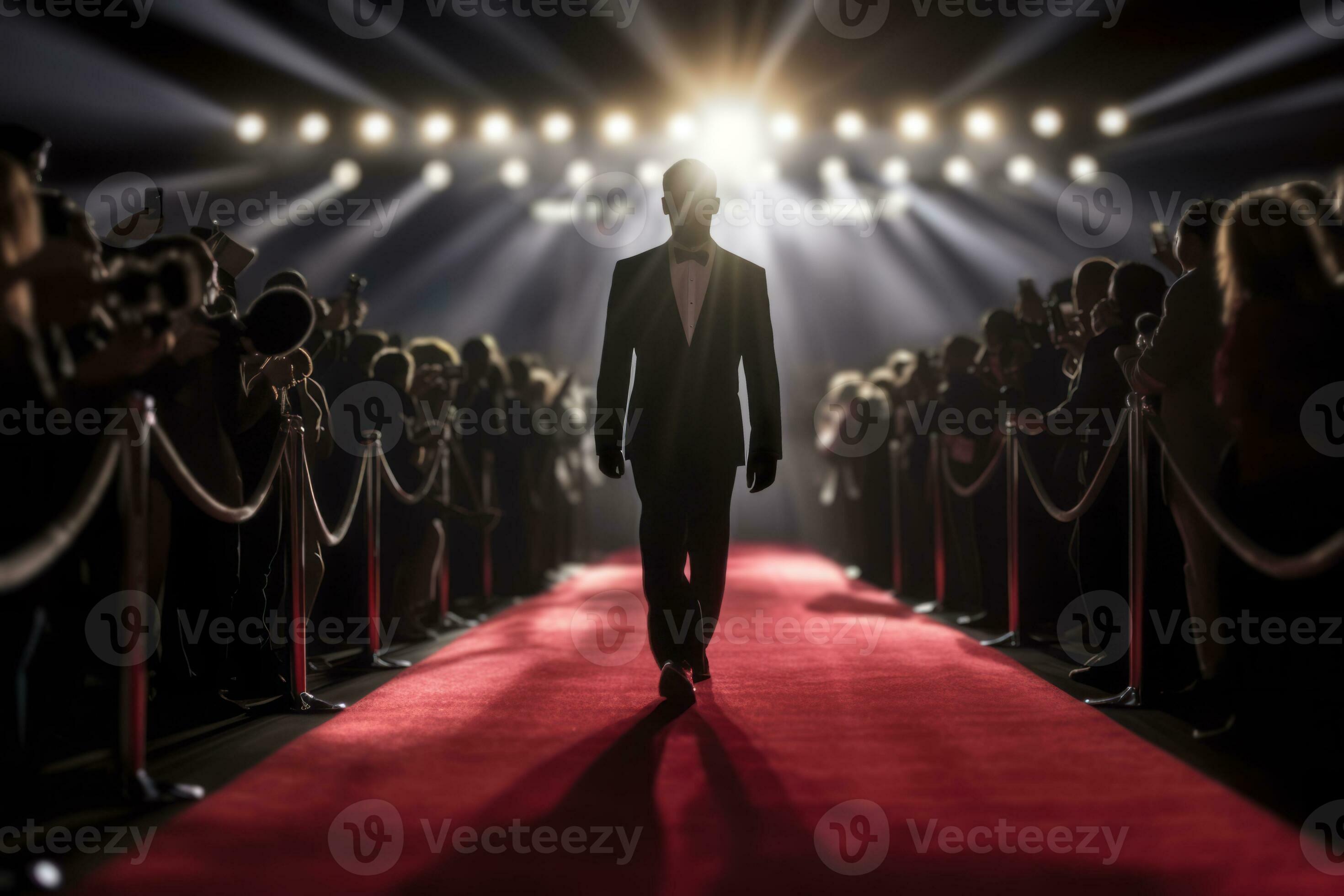 A glamourous celebrity posing for paparazzi pictures on the red carpet at an awards show ...