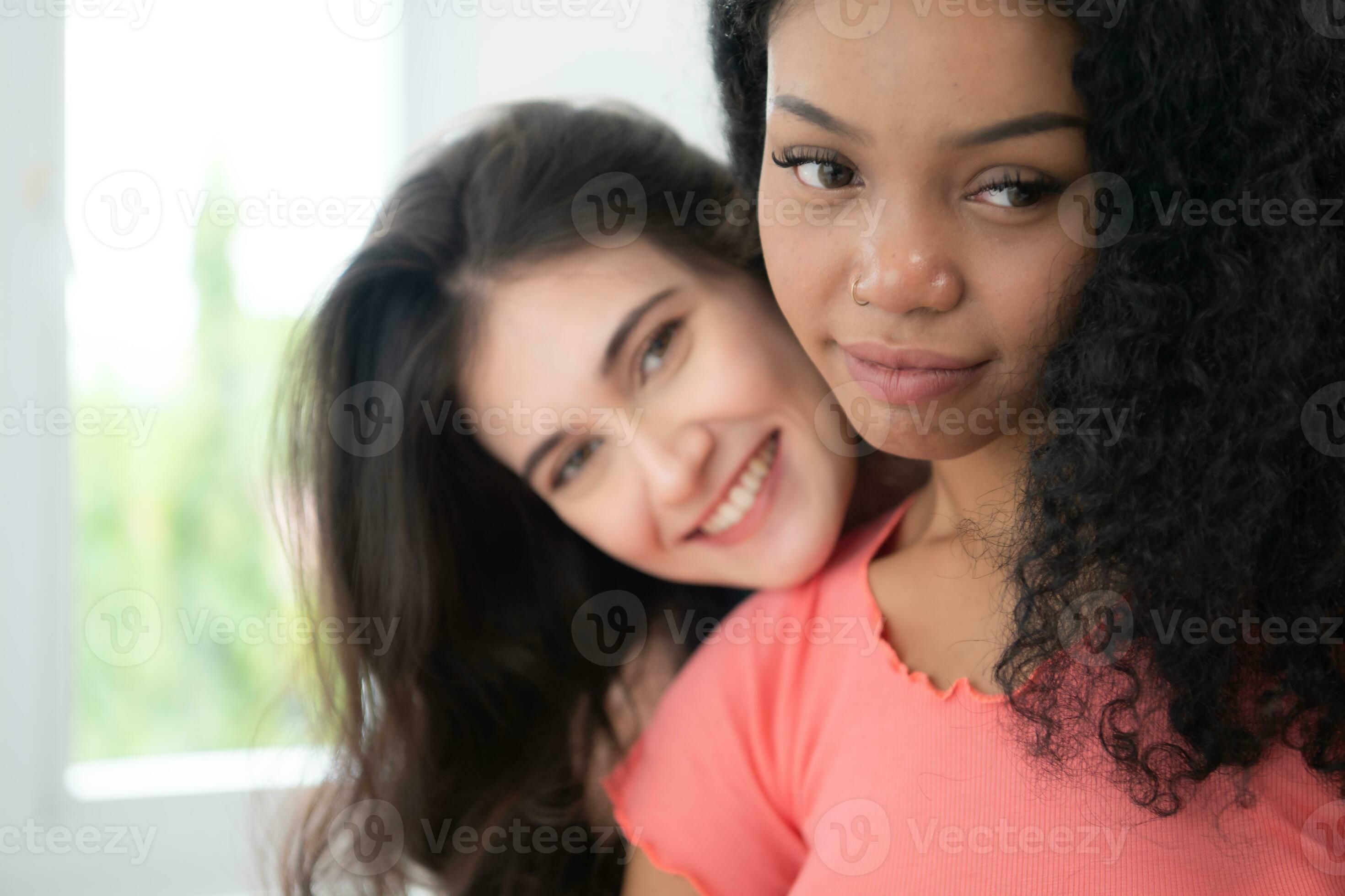 Happy Lesbian Couple Using Laptop On Bed At Home Young Multiethnic