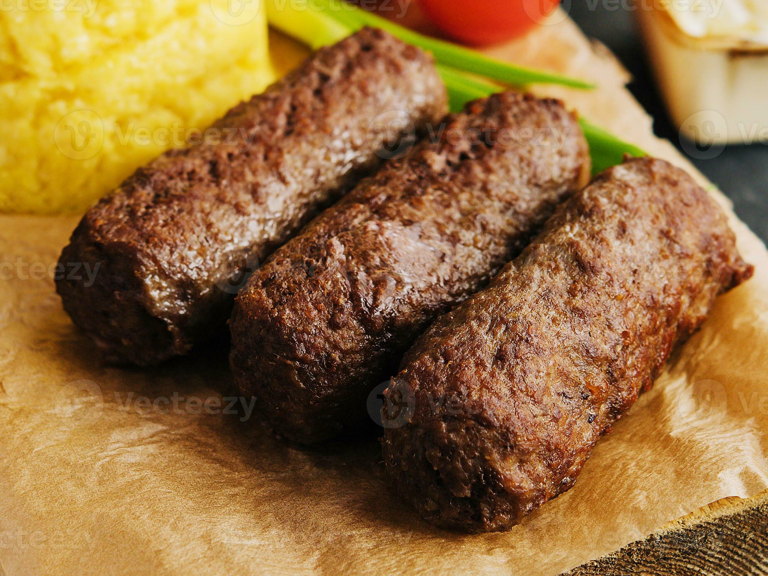 Traditional romanian grilled dish - mici or mititei 31754152 Stock Photo at Vecteezy