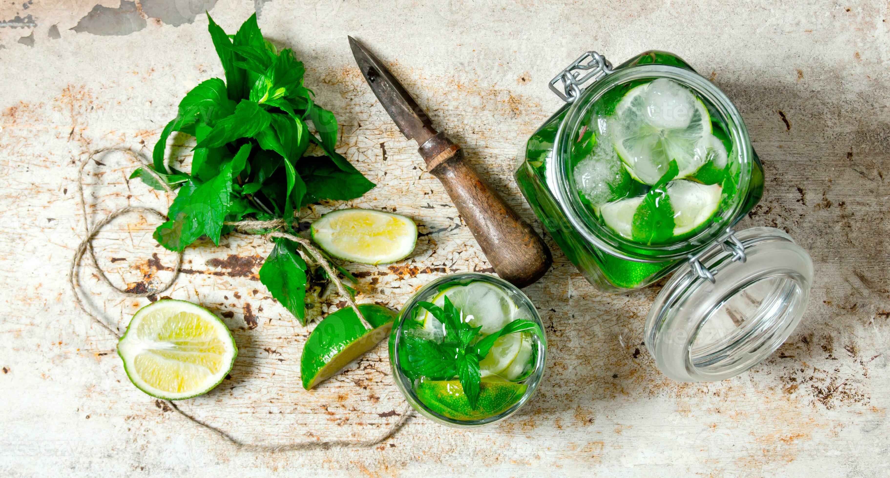 Ingredients For Making Mojitos Lime Mint Leaves Rum Citrus Knife And An Old Table 32031280