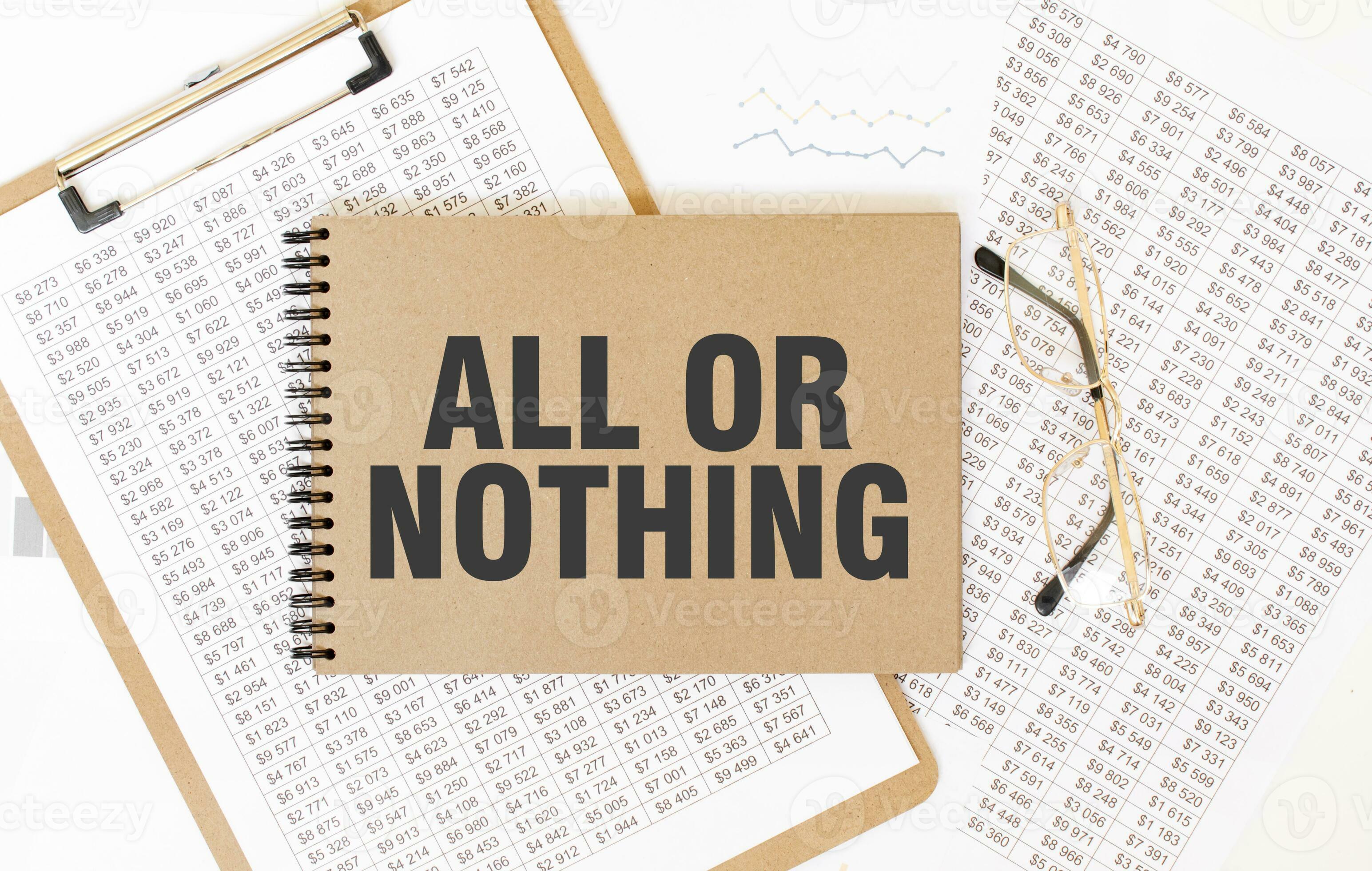 Craft colour notepad with text ALL OR NOTHING. Notepad with eyeglasses and text documents ...