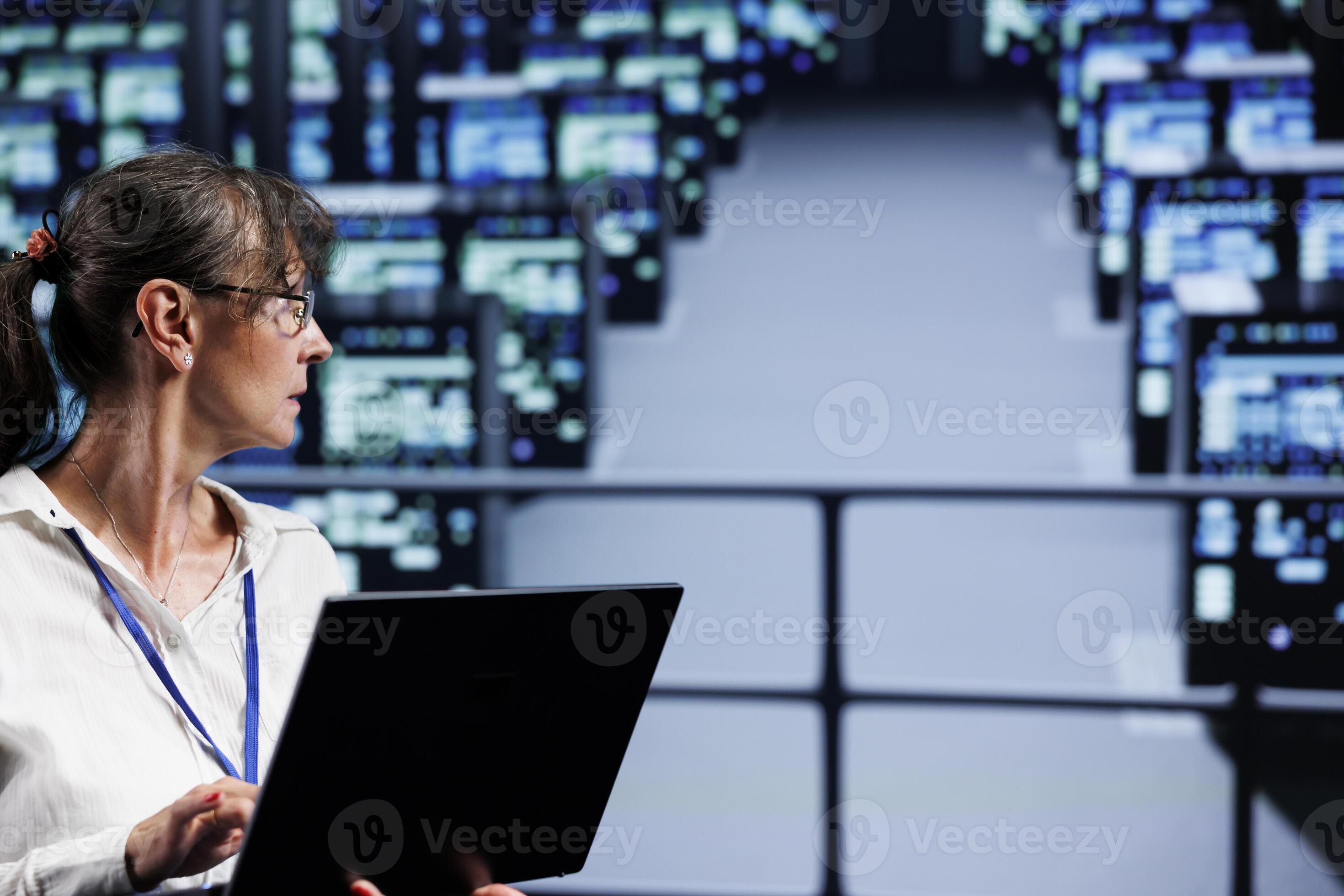 Experienced Technician In Data Center Working On Laptop Setting Up High Bandwidth Dedicated