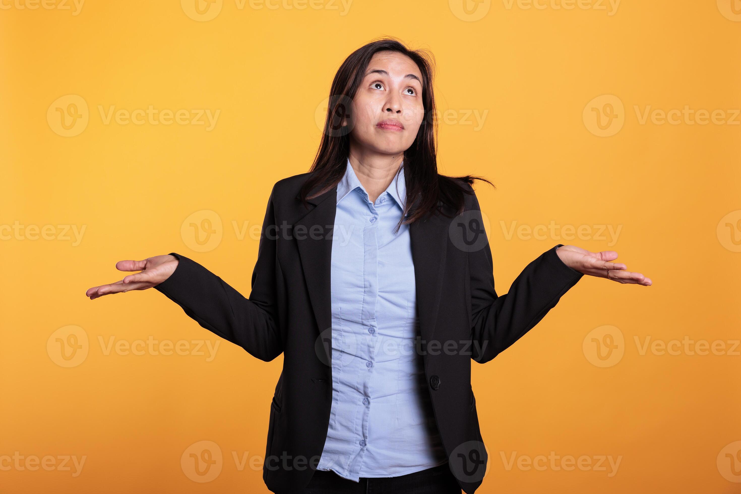 Asian woman shrugging shoulders doing i dont know sign, having doubtful ...
