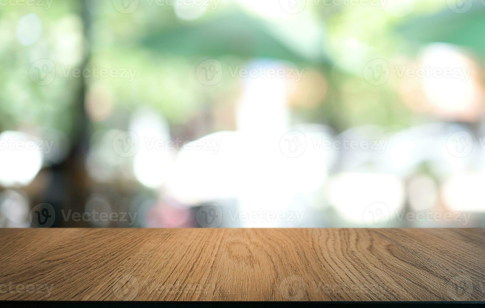 Empty wooden table in front of abstract blurred background of coffee shop . can be used for ...