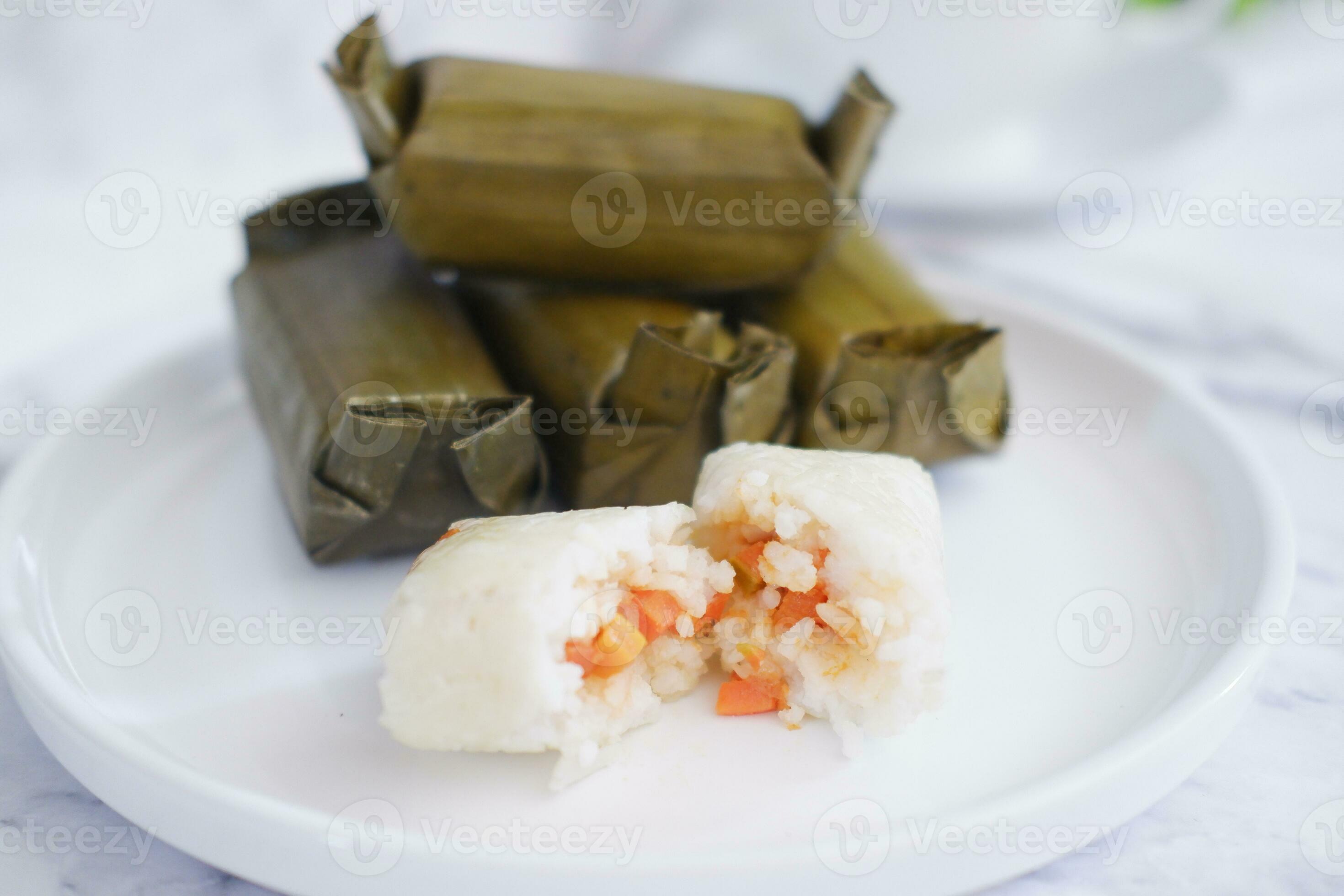 Arem-arem, a traditional food made from rice filled with vegetables, chicken, meat or tempeh ...