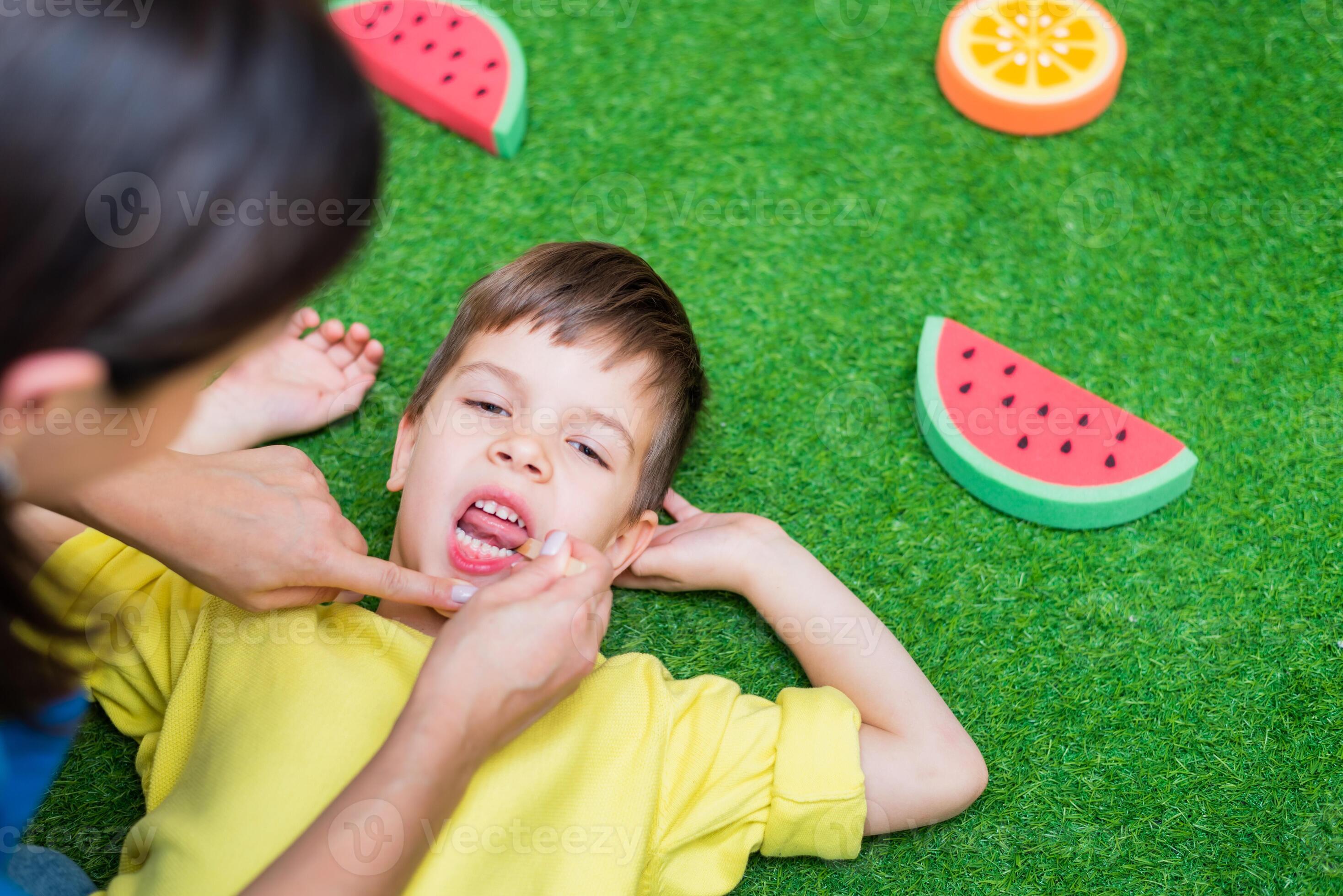 A little boy is engaged in a speech therapist's office and corrects his ... A little boy is engaged in a speech therapist's office and corrects his ...